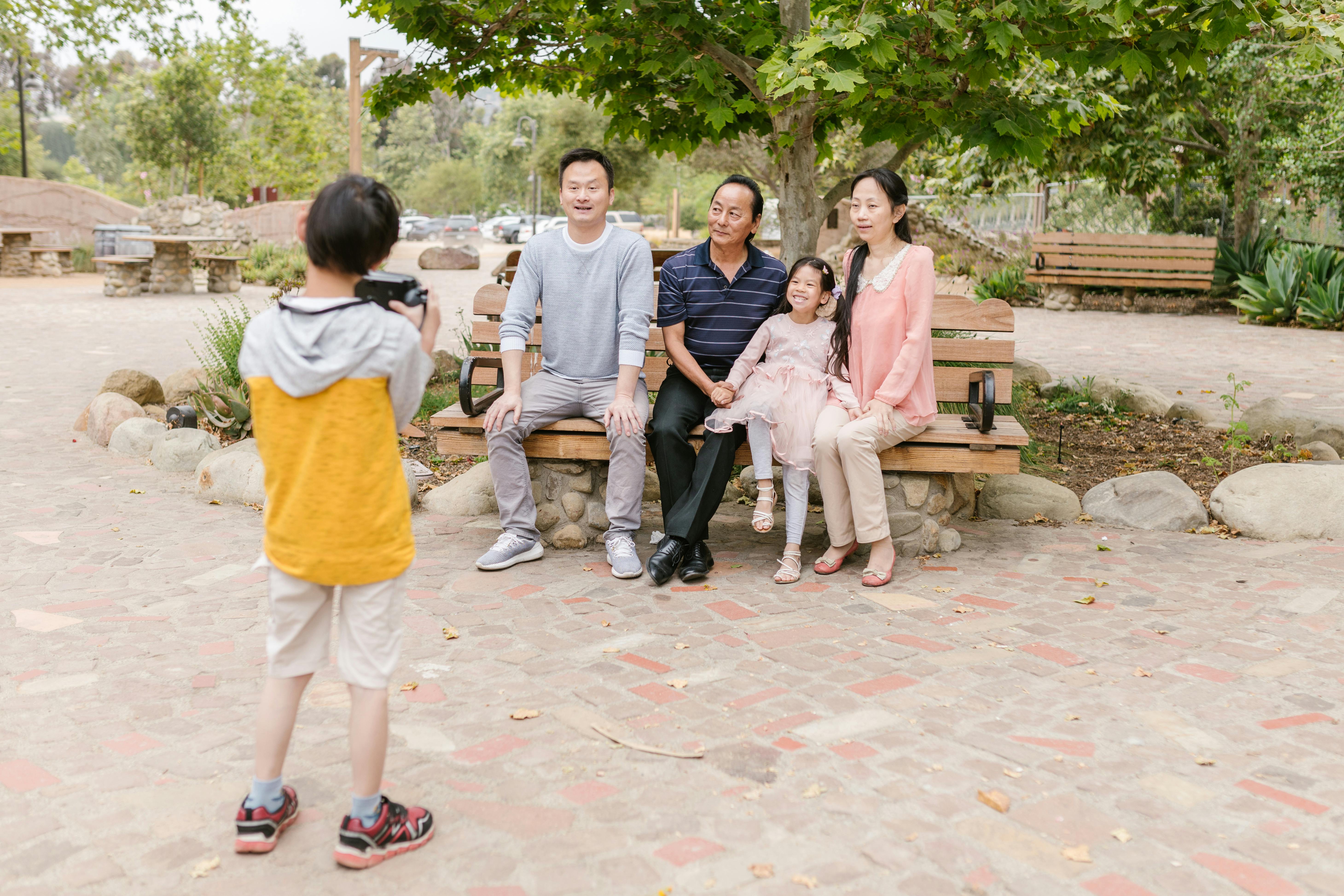 Group of People Sitting on Brown Wooden Bench · Free Stock Photo