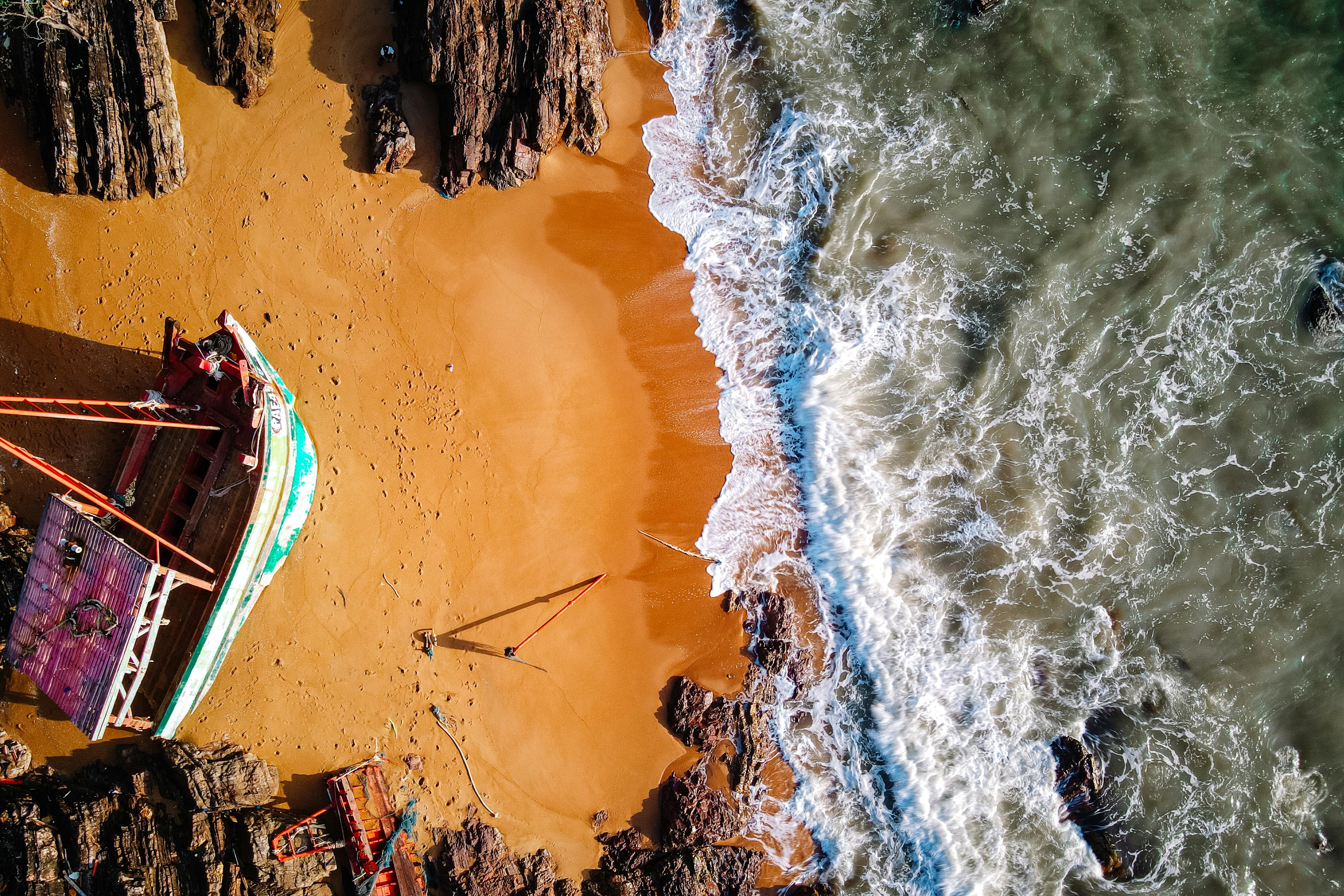 Top View of Boat Wreck on Beach · Free Stock Photo
