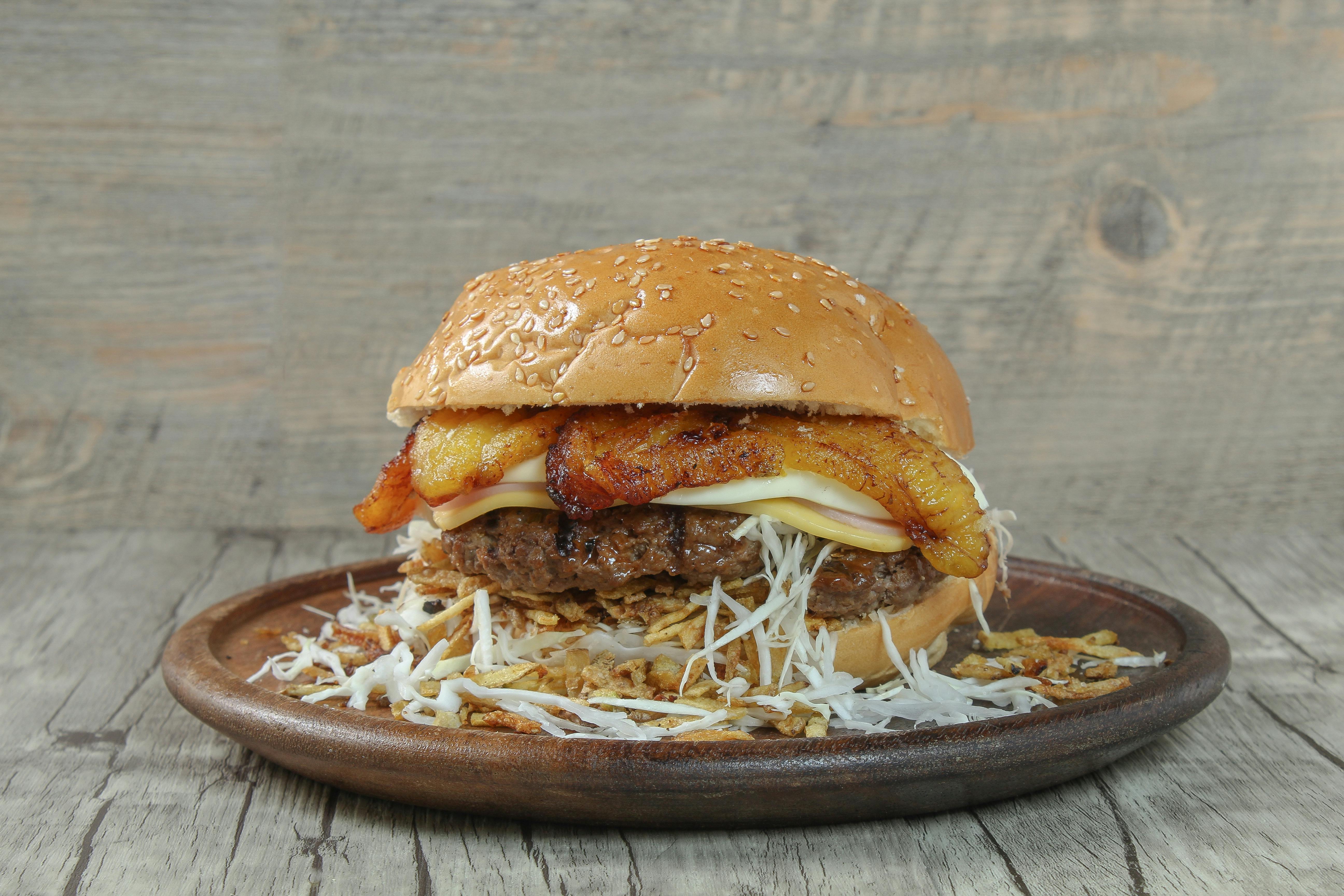 Burger on Brown Ceramic Plate · Free Stock Photo