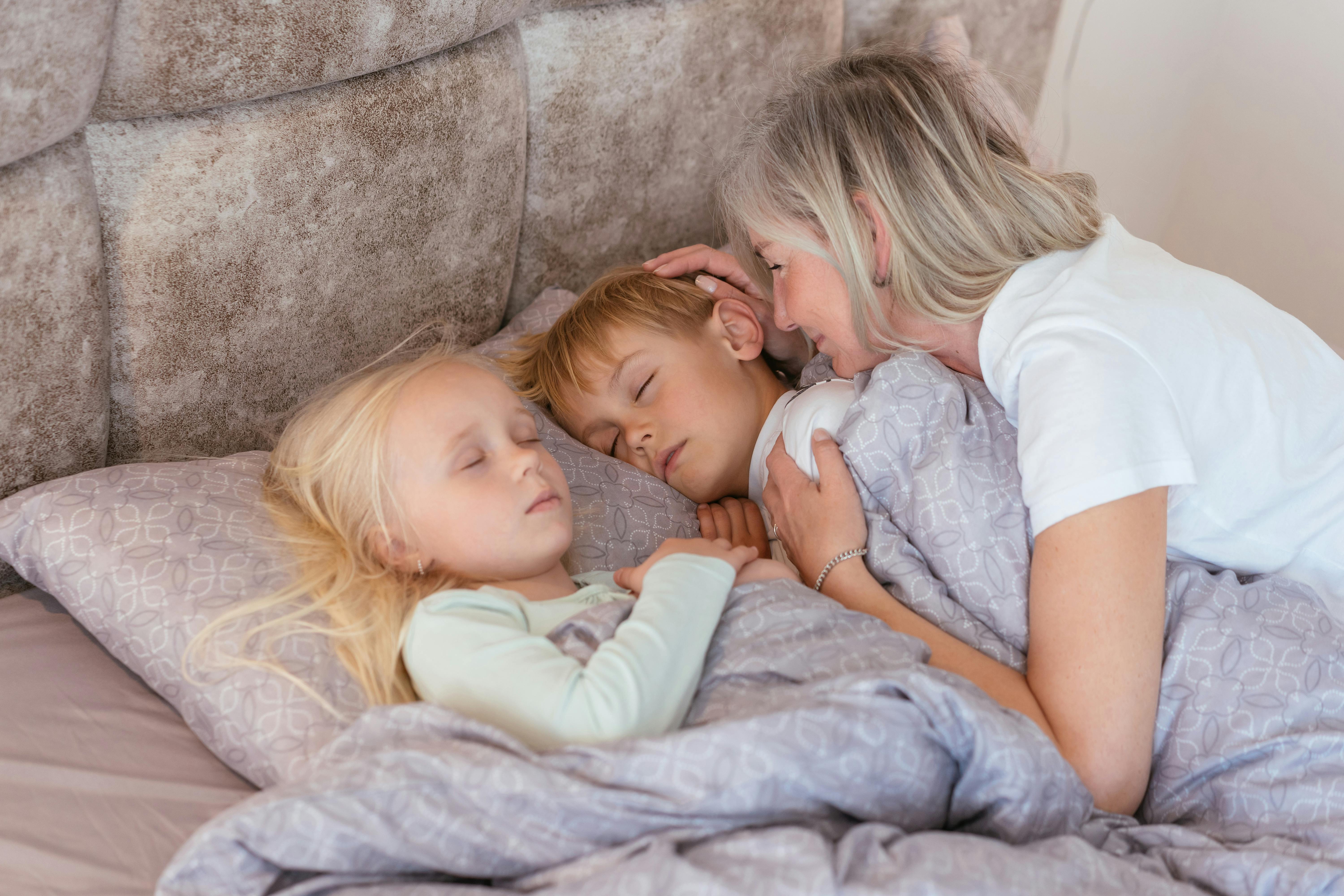 Woman Putting the Kids to Sleep · Free Stock Photo