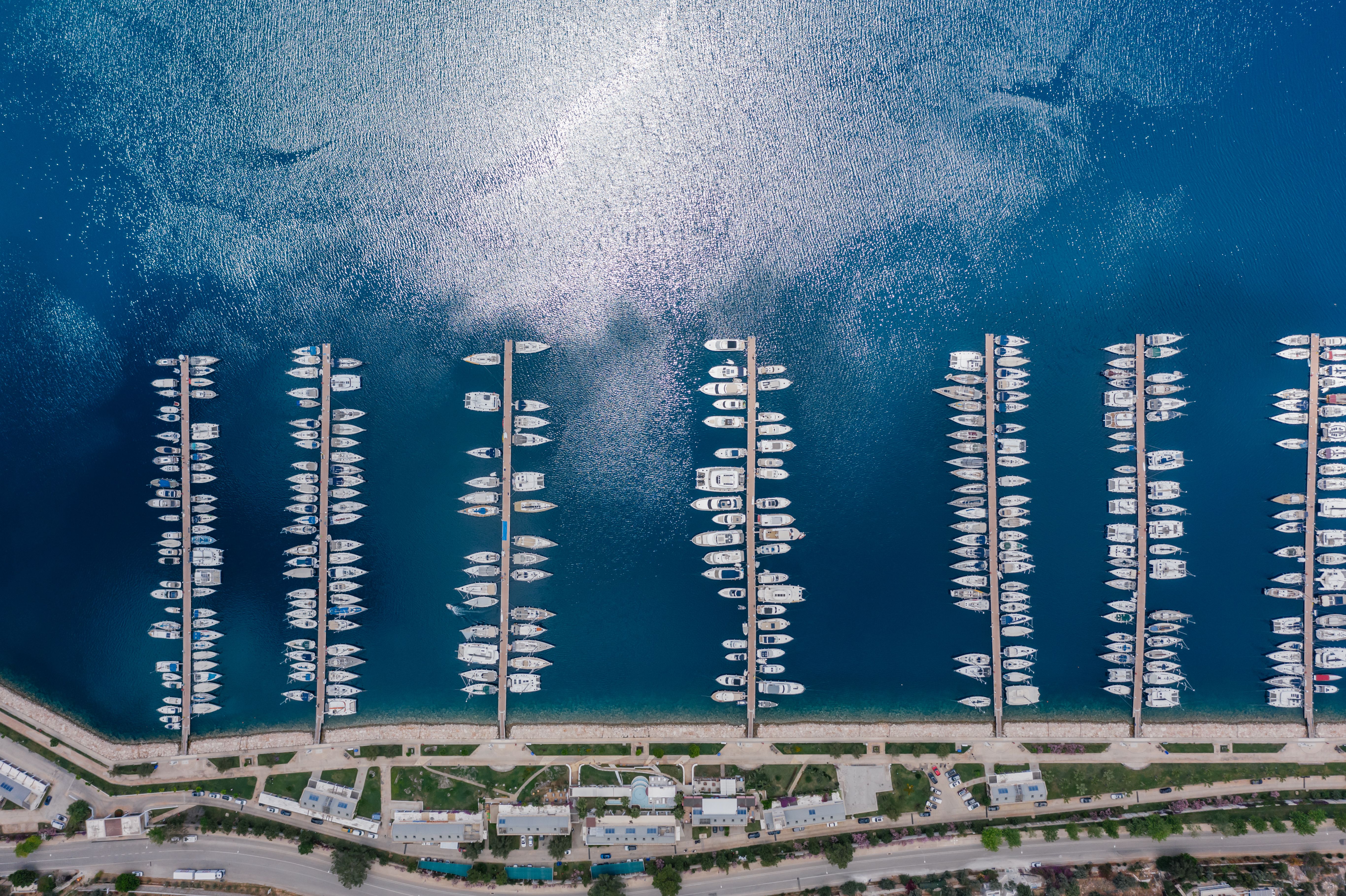 Top View of a Marina and Sun Reflecting in the Sea · Free Stock Photo