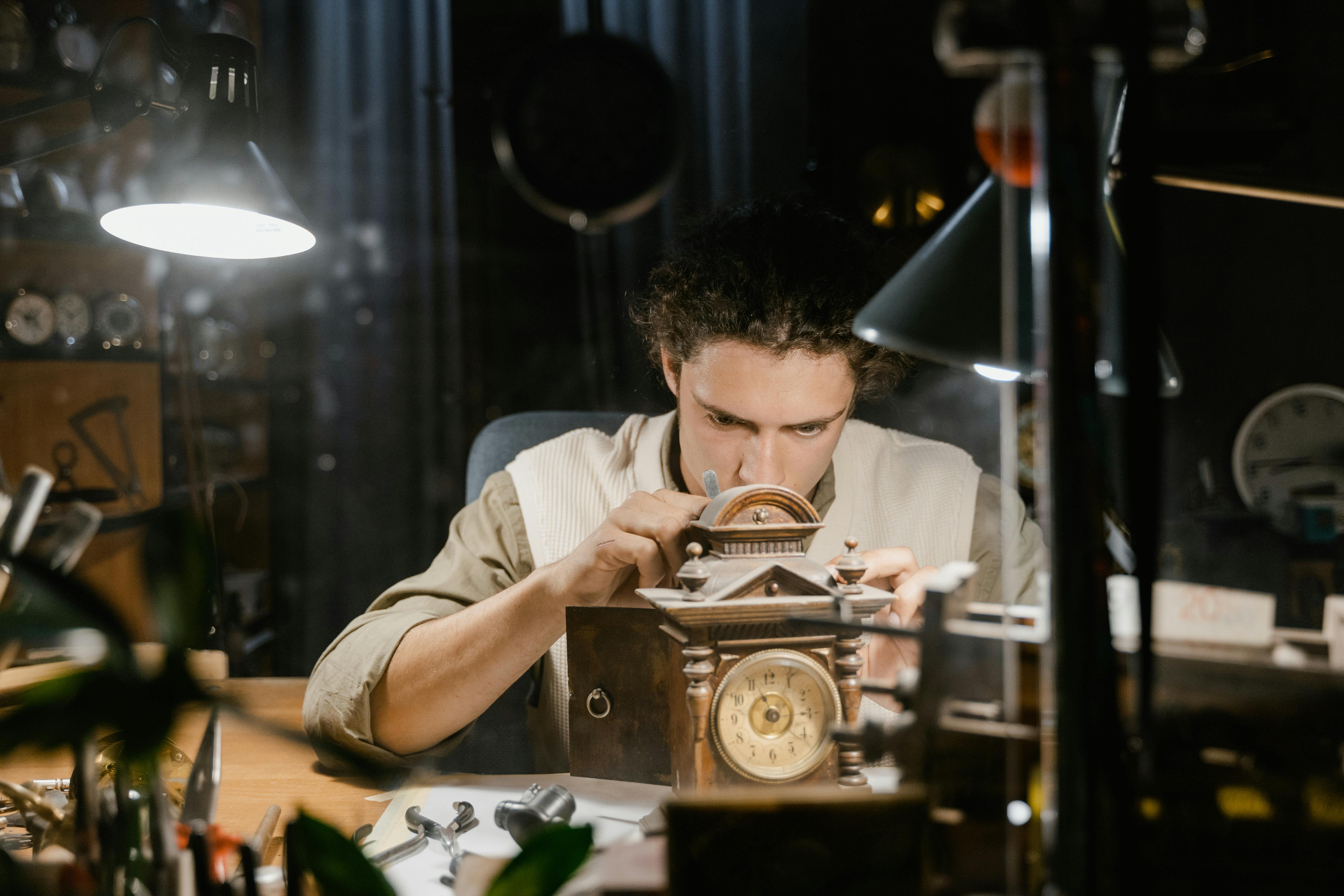 Watchmaker in a Watch Repair Shop Fixing a Wall Clock · Free Stock Photo