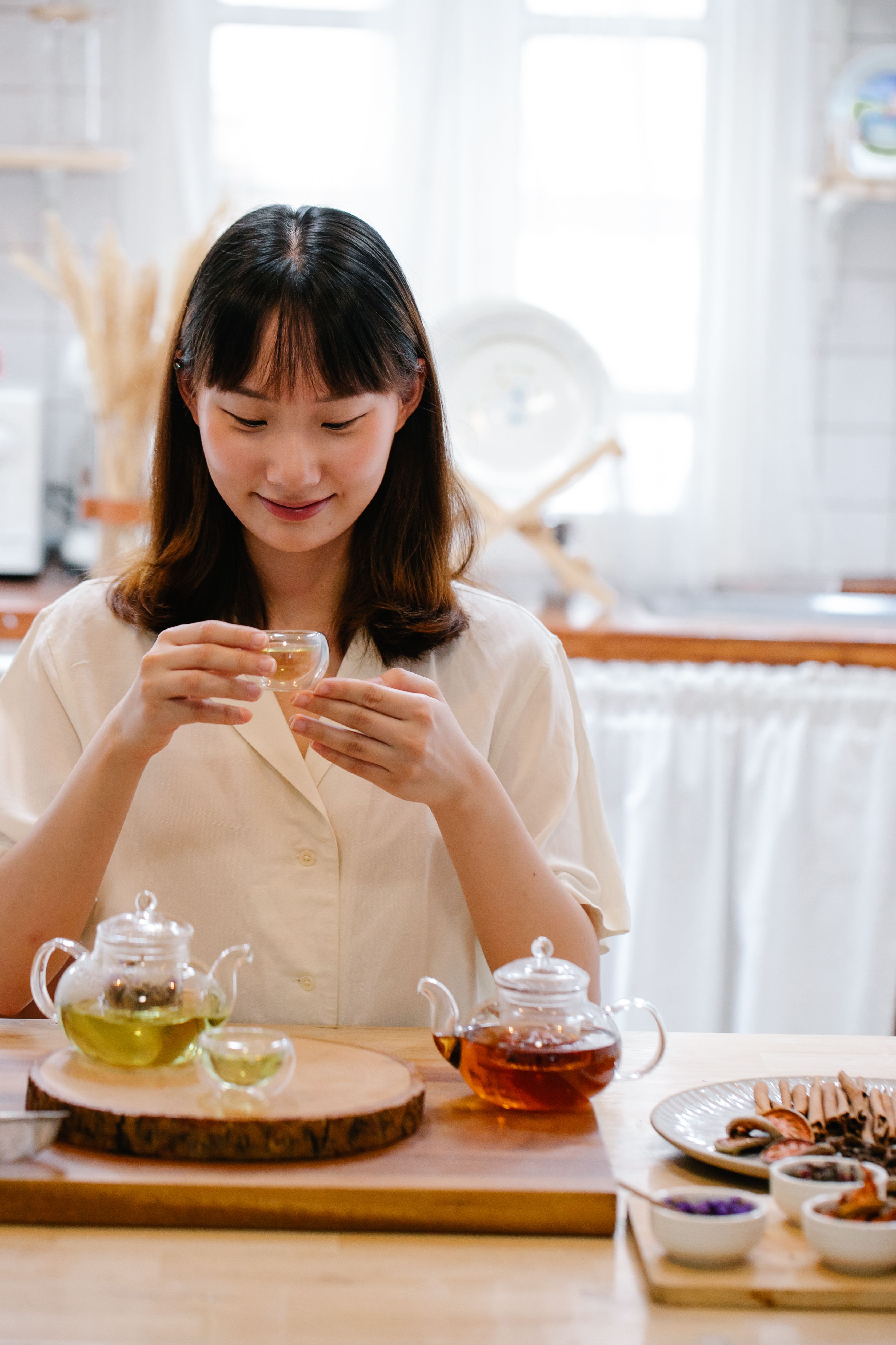 Woman Preparing Tea at the Table · Free Stock Photo