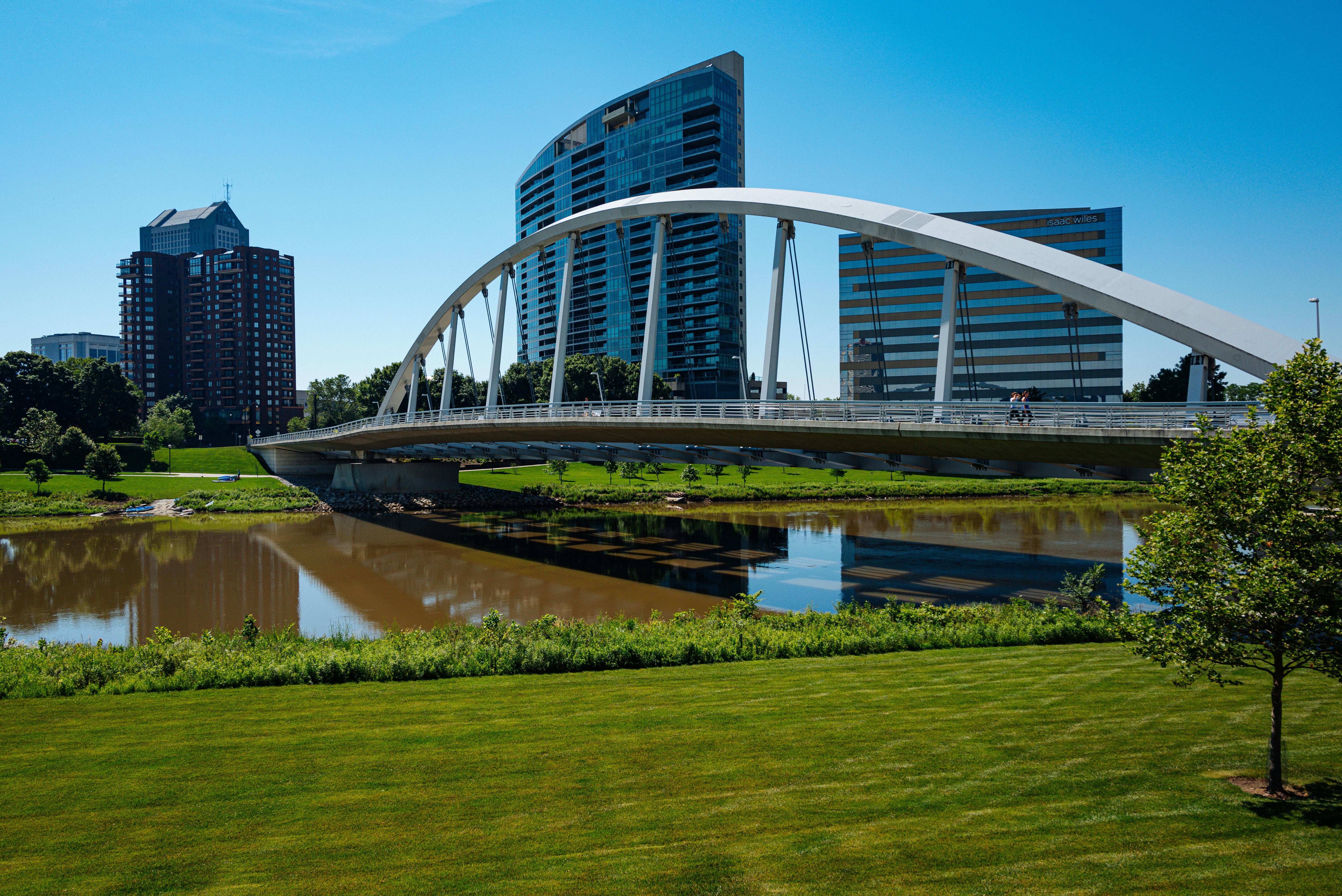 Modern Bridge over River and Buildings · Free Stock Photo