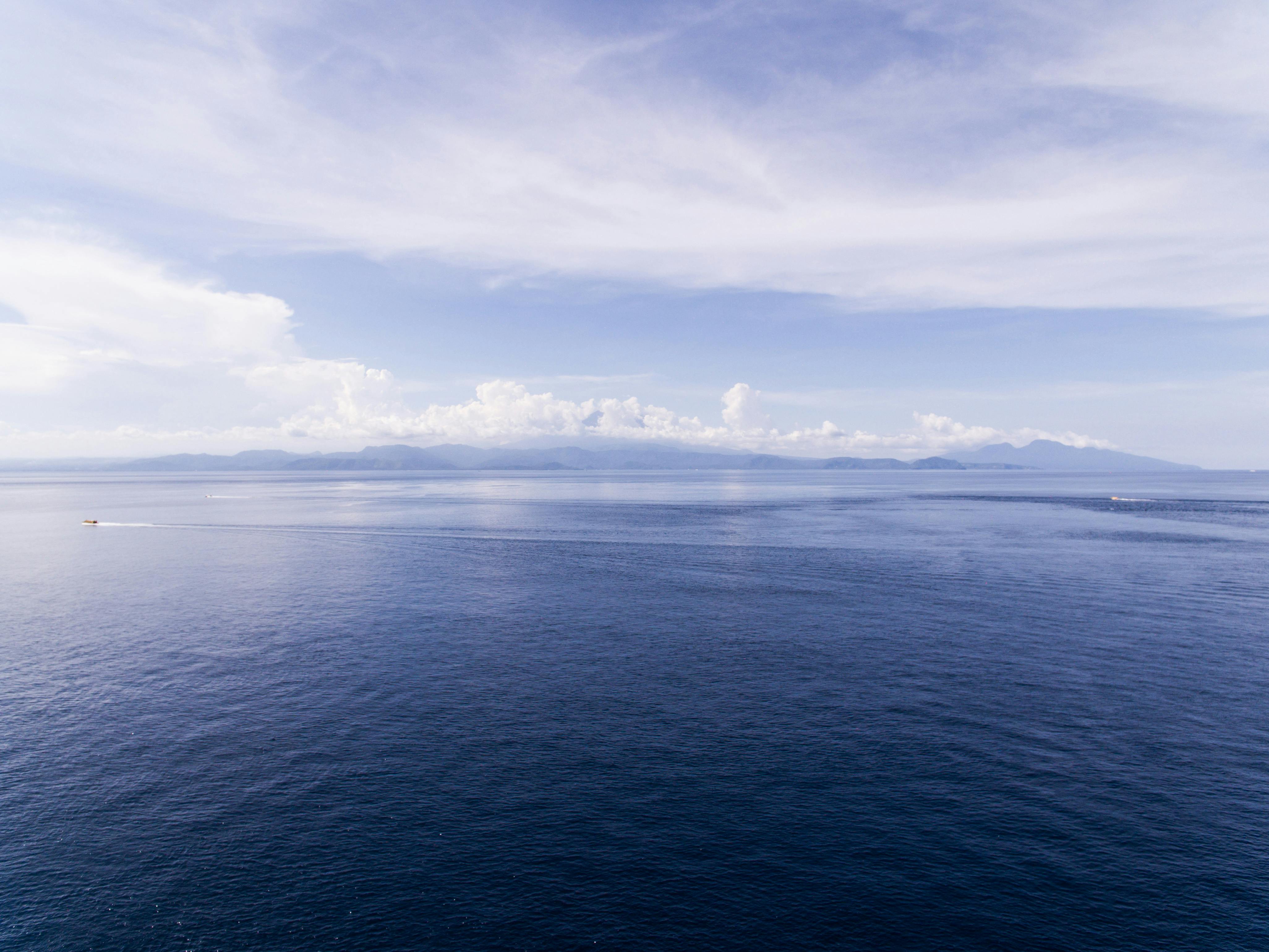 Calm Water in the Sea Under Purple Sky · Free Stock Photo
