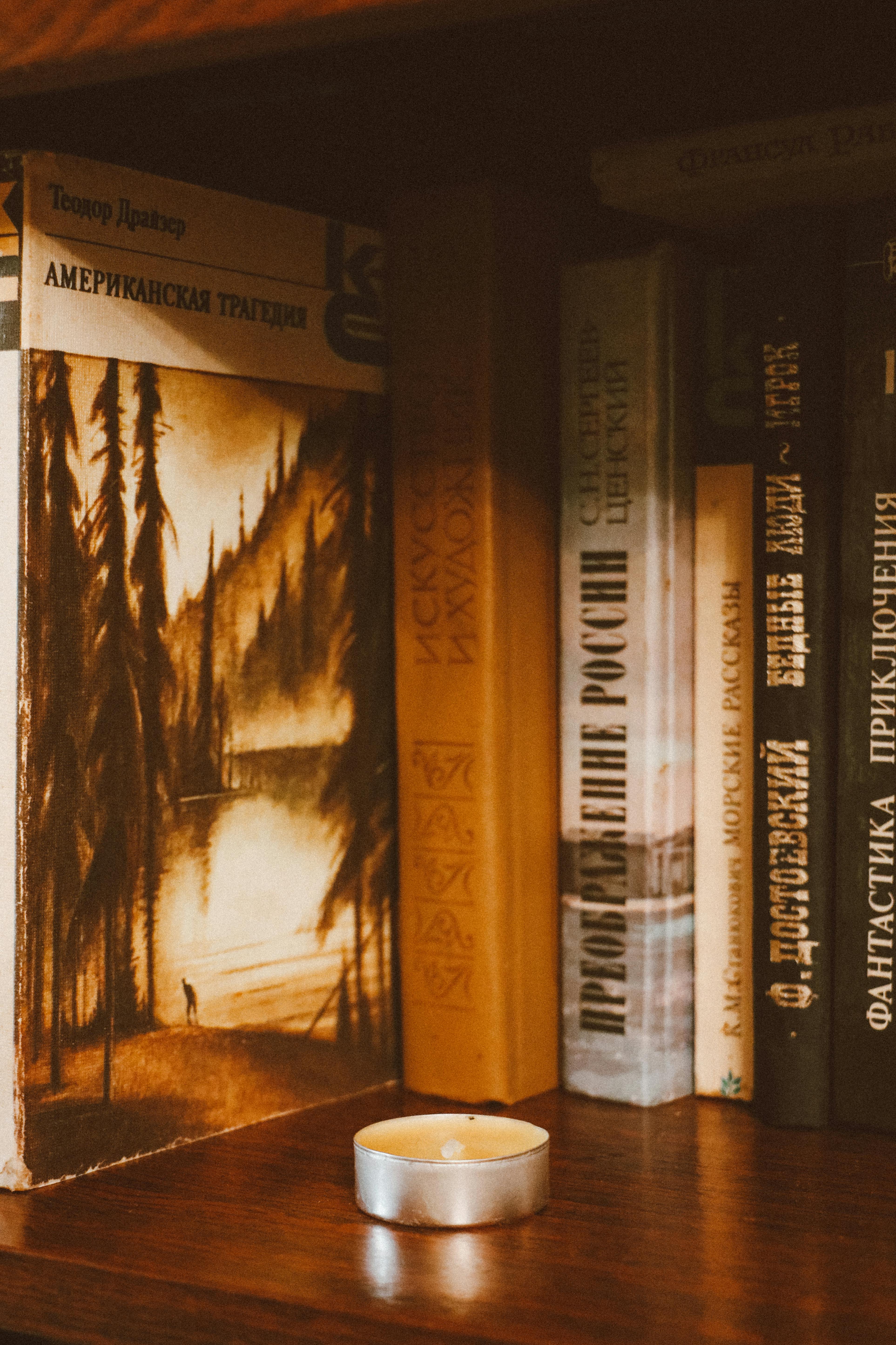 Candle Light Beside the Books · Free Stock Photo