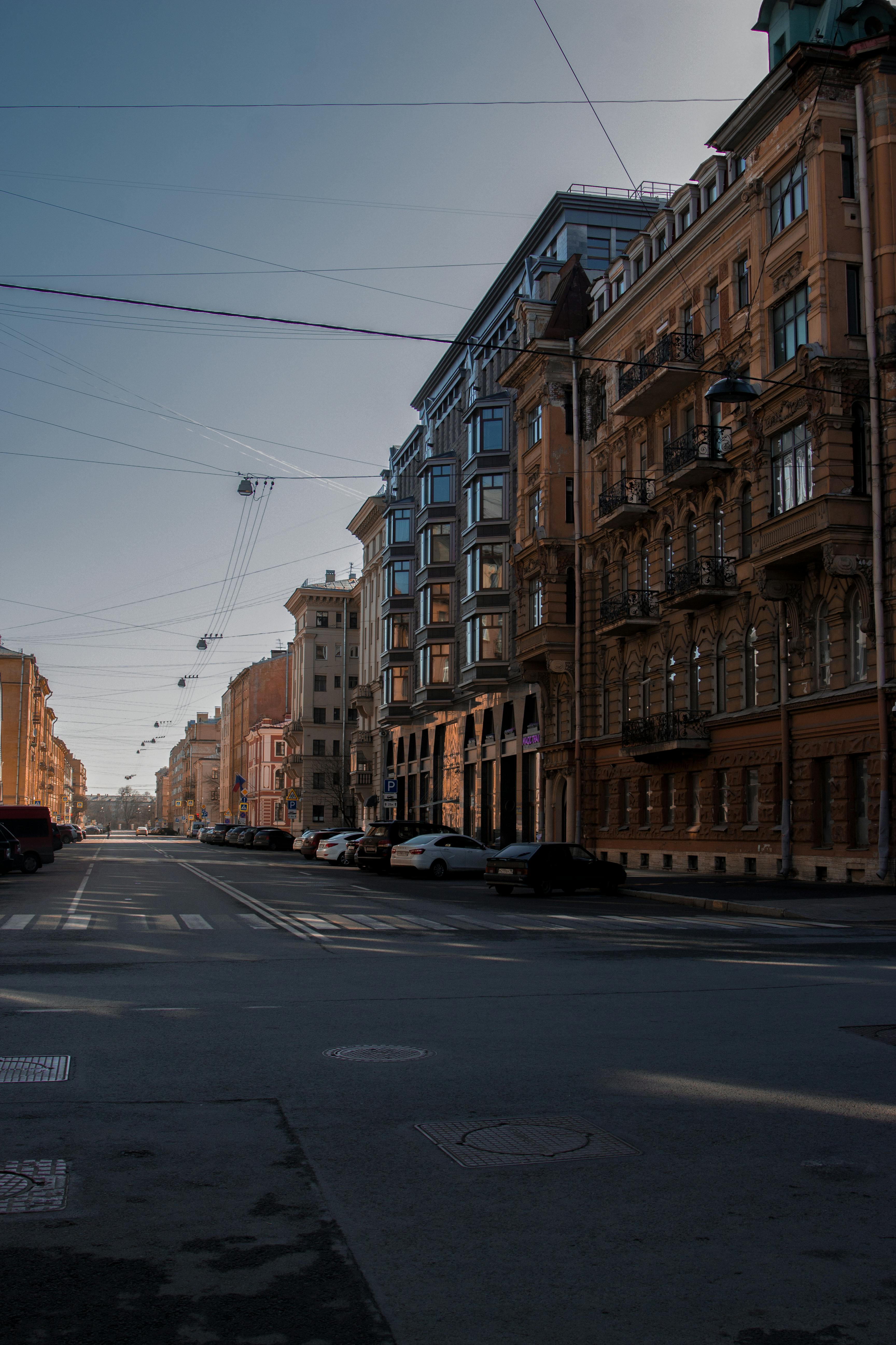 Woman Sitting on a Building Ledge · Free Stock Photo