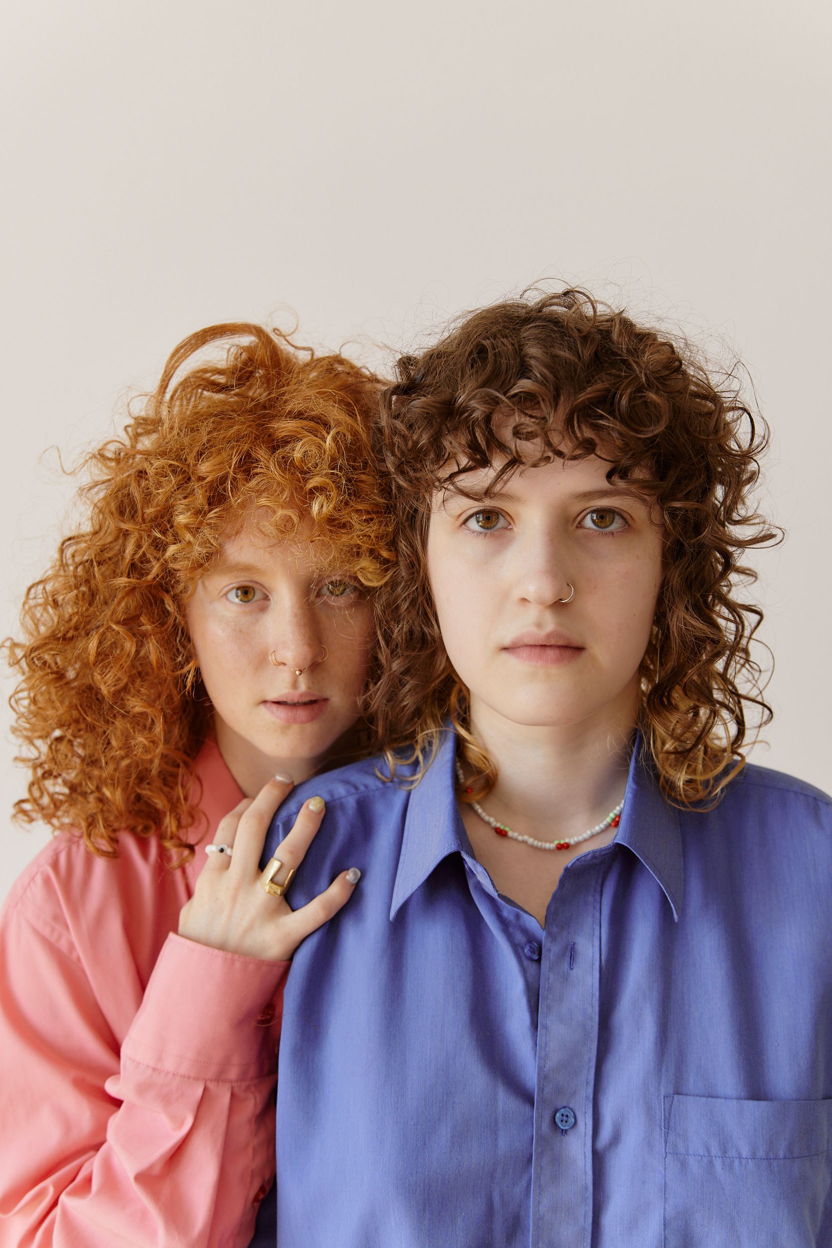 Portrait of Two Young Women with Curly Hair · Free Stock Photo