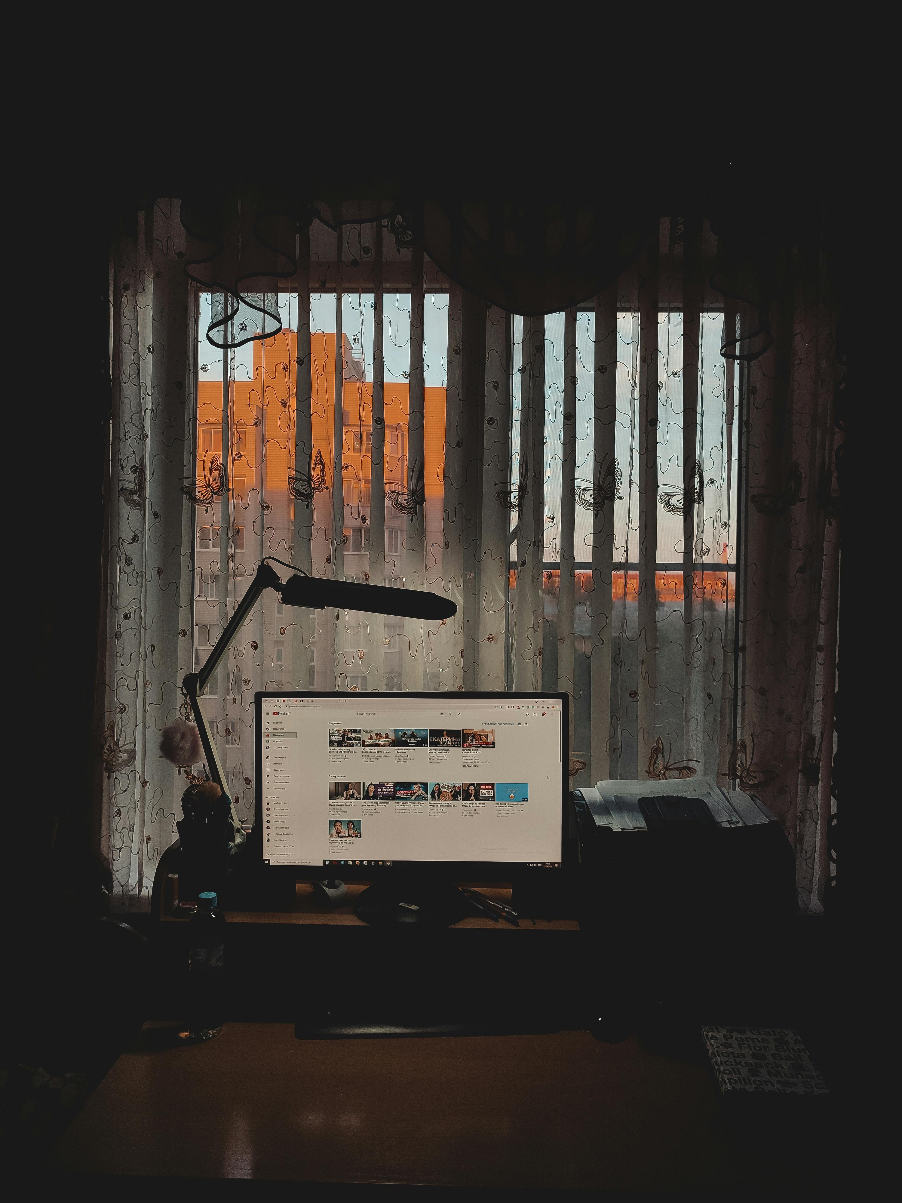 Photo of a Computer Screen in front of the Window · Free Stock Photo