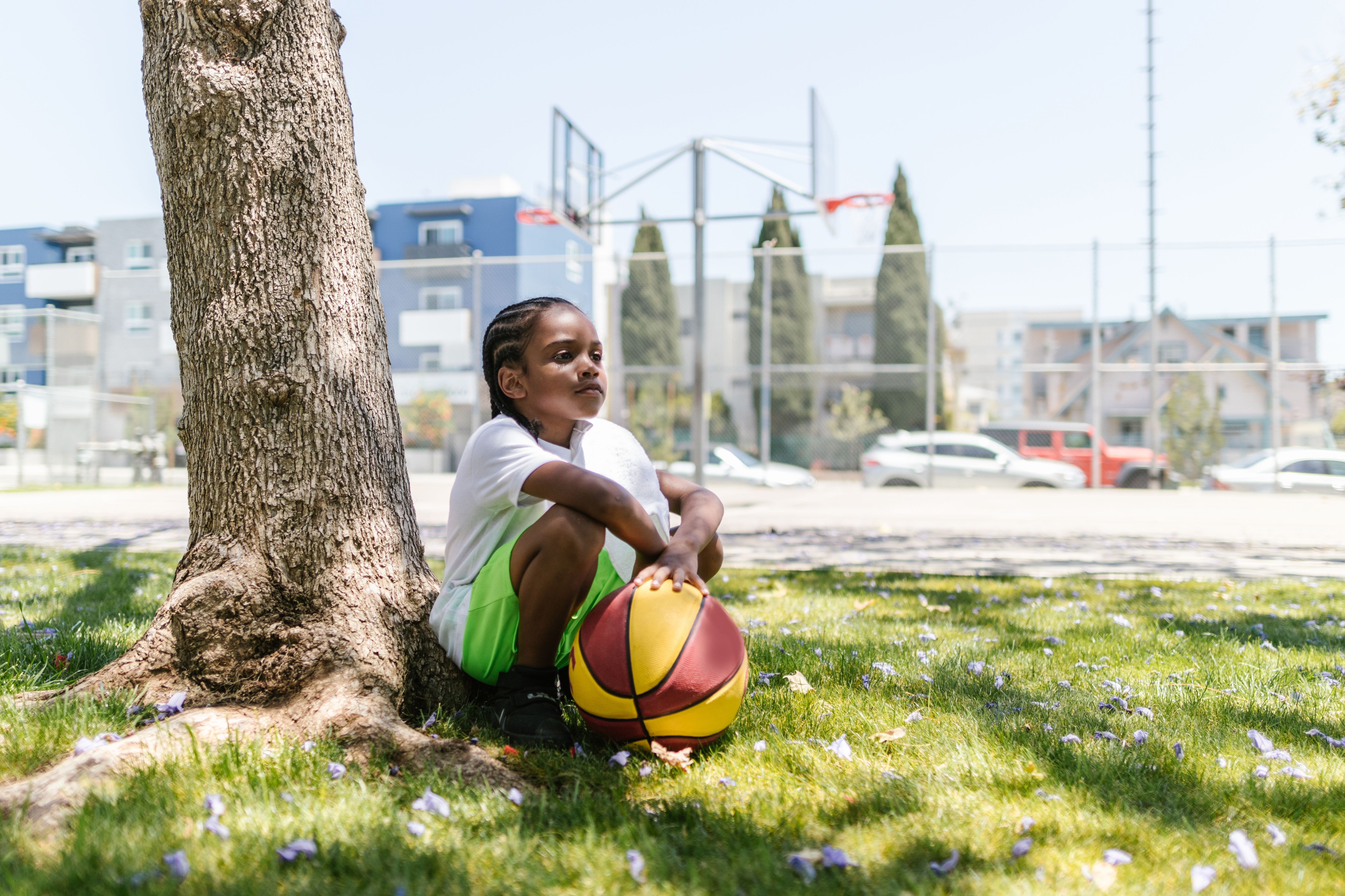 A Child Sitting Under a Tree · Free Stock Photo