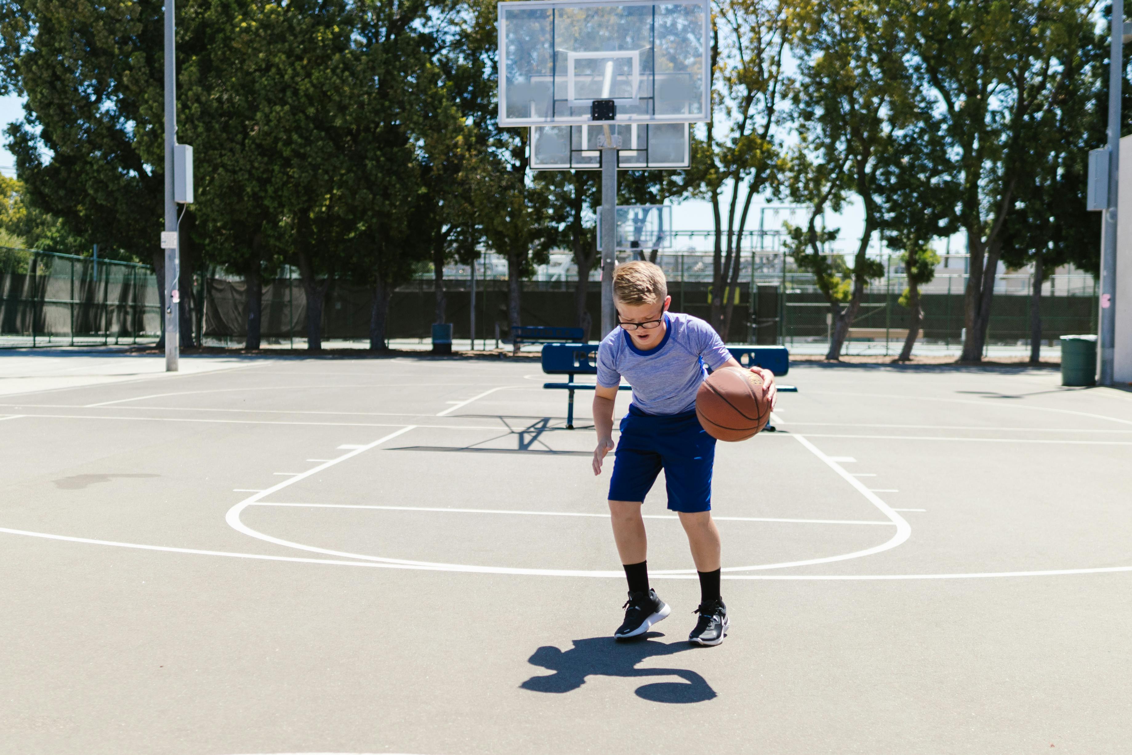 Boy Dribbling the Ball · Free Stock Photo