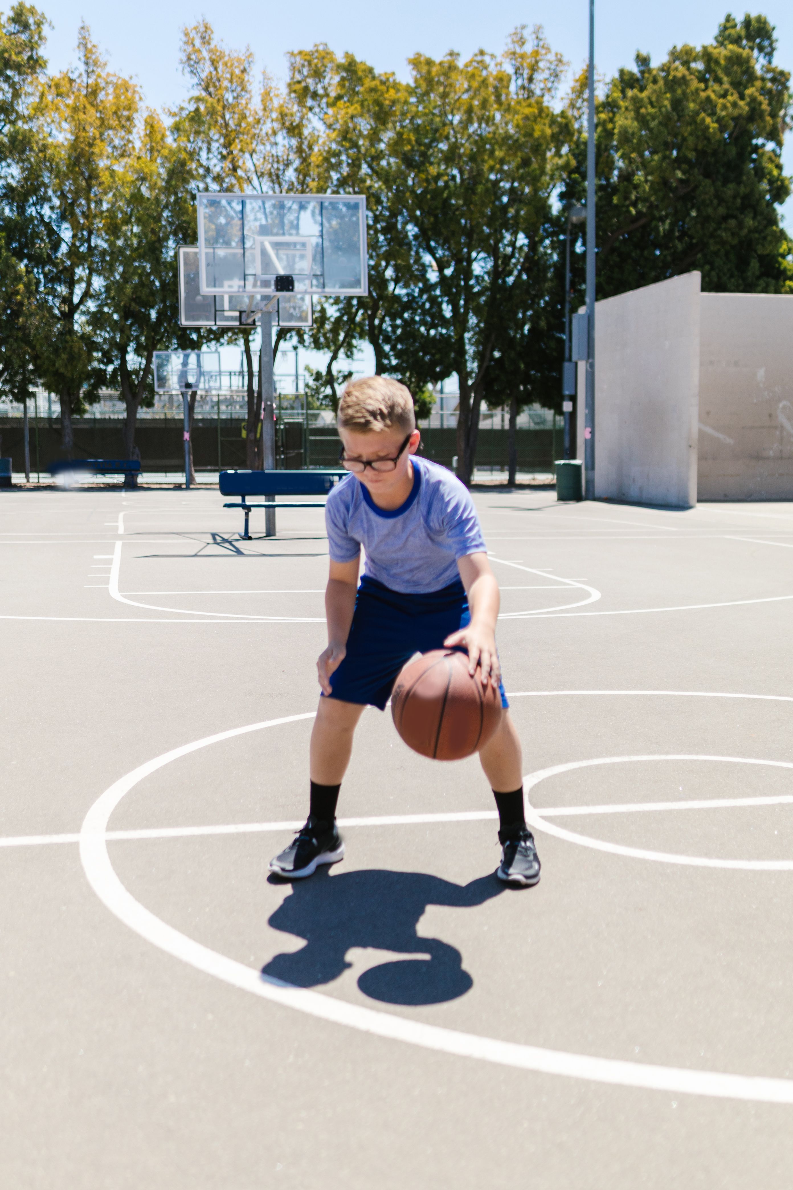 Kid Shooting a Ball to a Basketball Hoop · Free Stock Photo