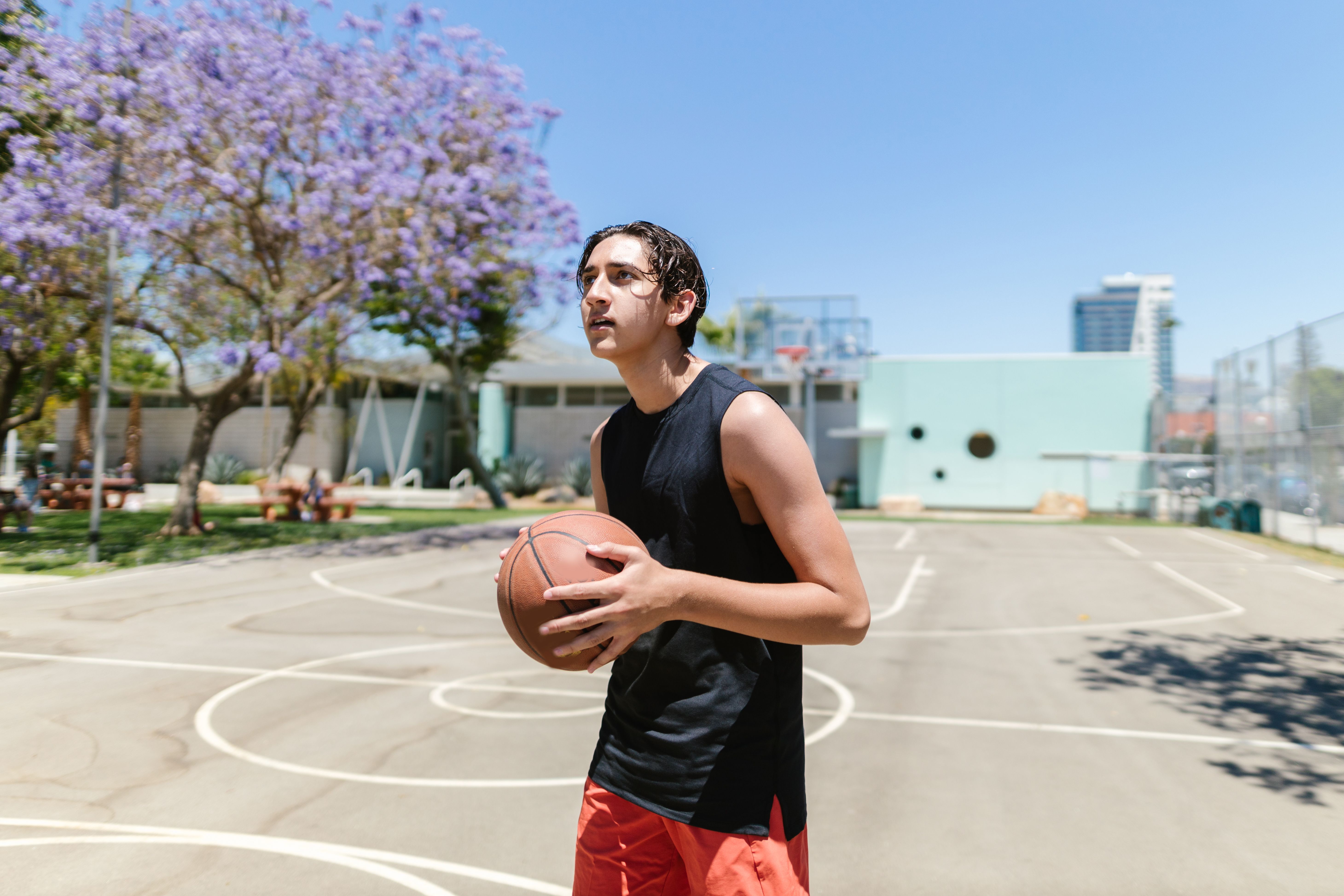 Man Wearing Tank Top Carrying a Sports Bag · Free Stock Photo