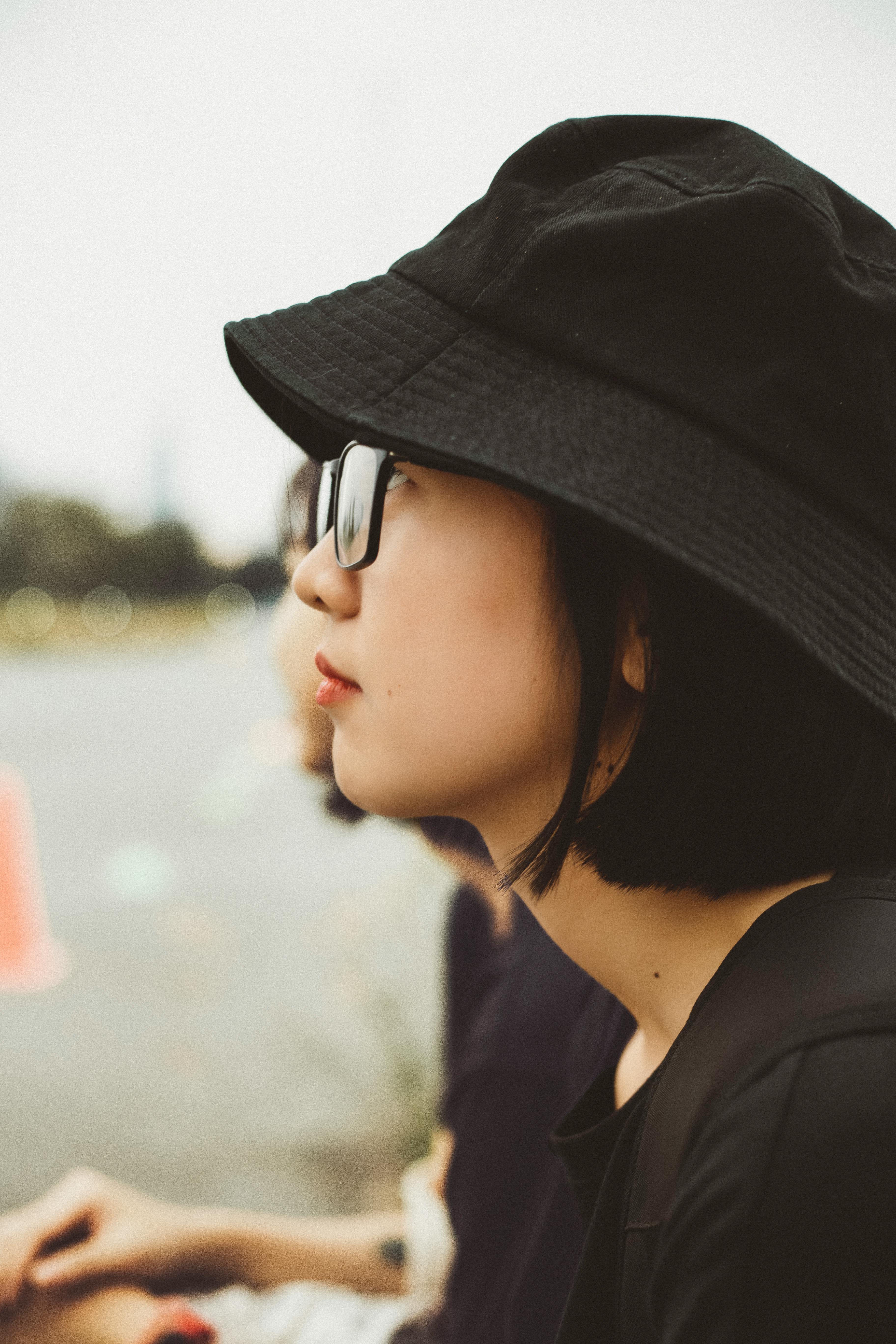 Woman in Black Bucket Hat and Eyeglasses · Free Stock Photo