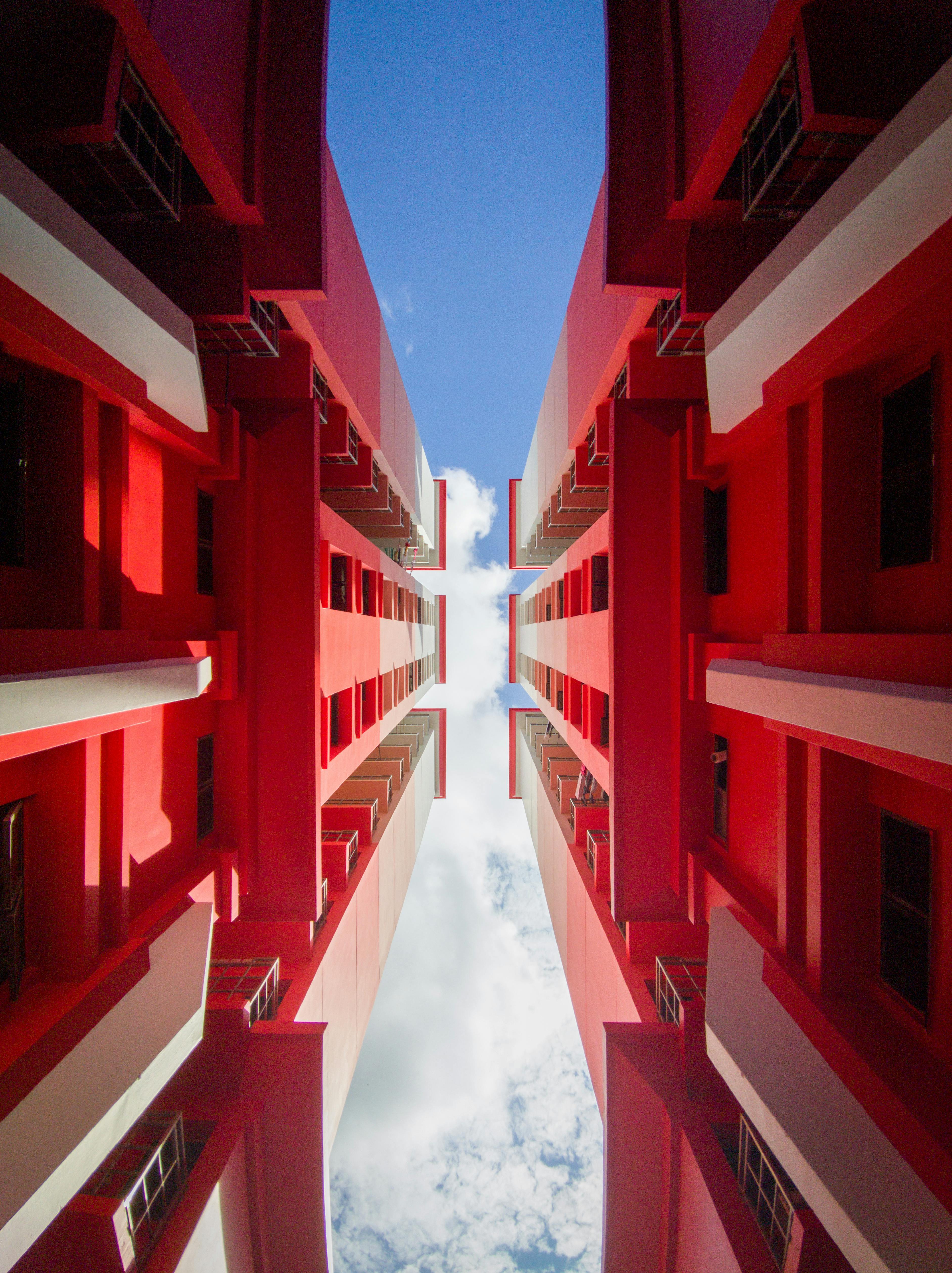 Red and White High Rise Concrete Buildings · Free Stock Photo