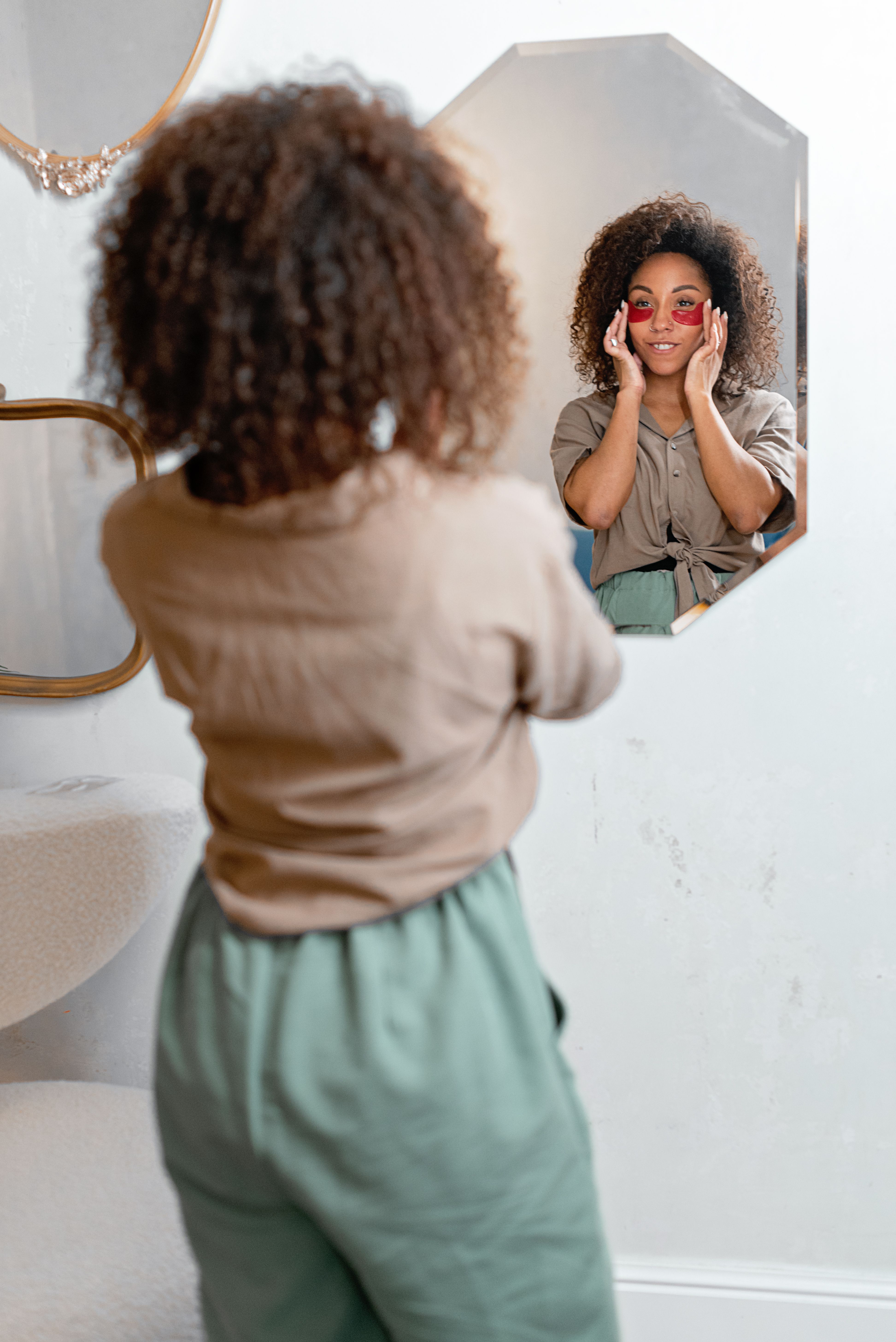 Mirror Reflection of a Curly-Haired Woman · Free Stock Photo
