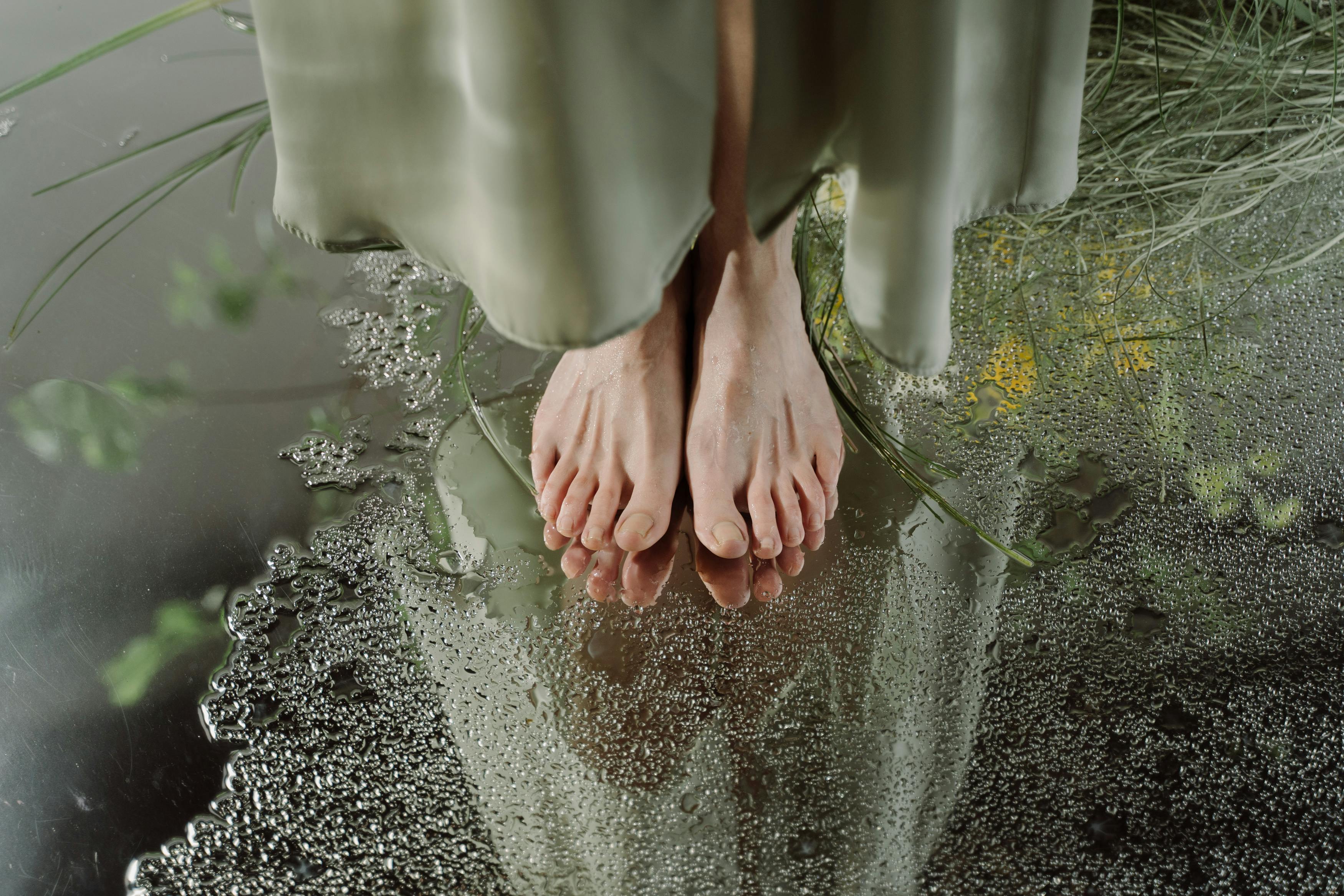 A Person Stepping on a Puddle · Free Stock Photo