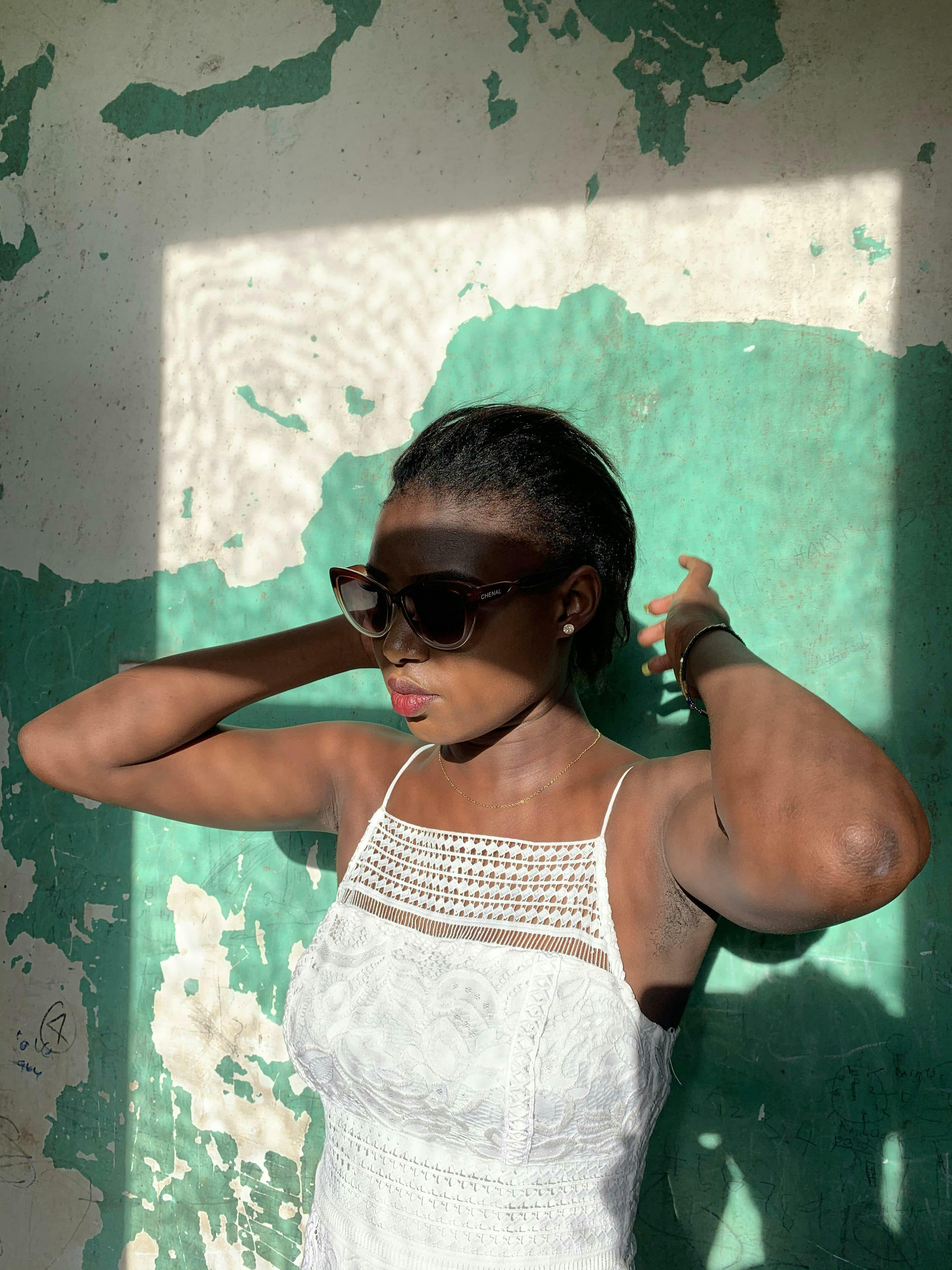 Woman Shielding from Sunlight with Hand · Free Stock Photo