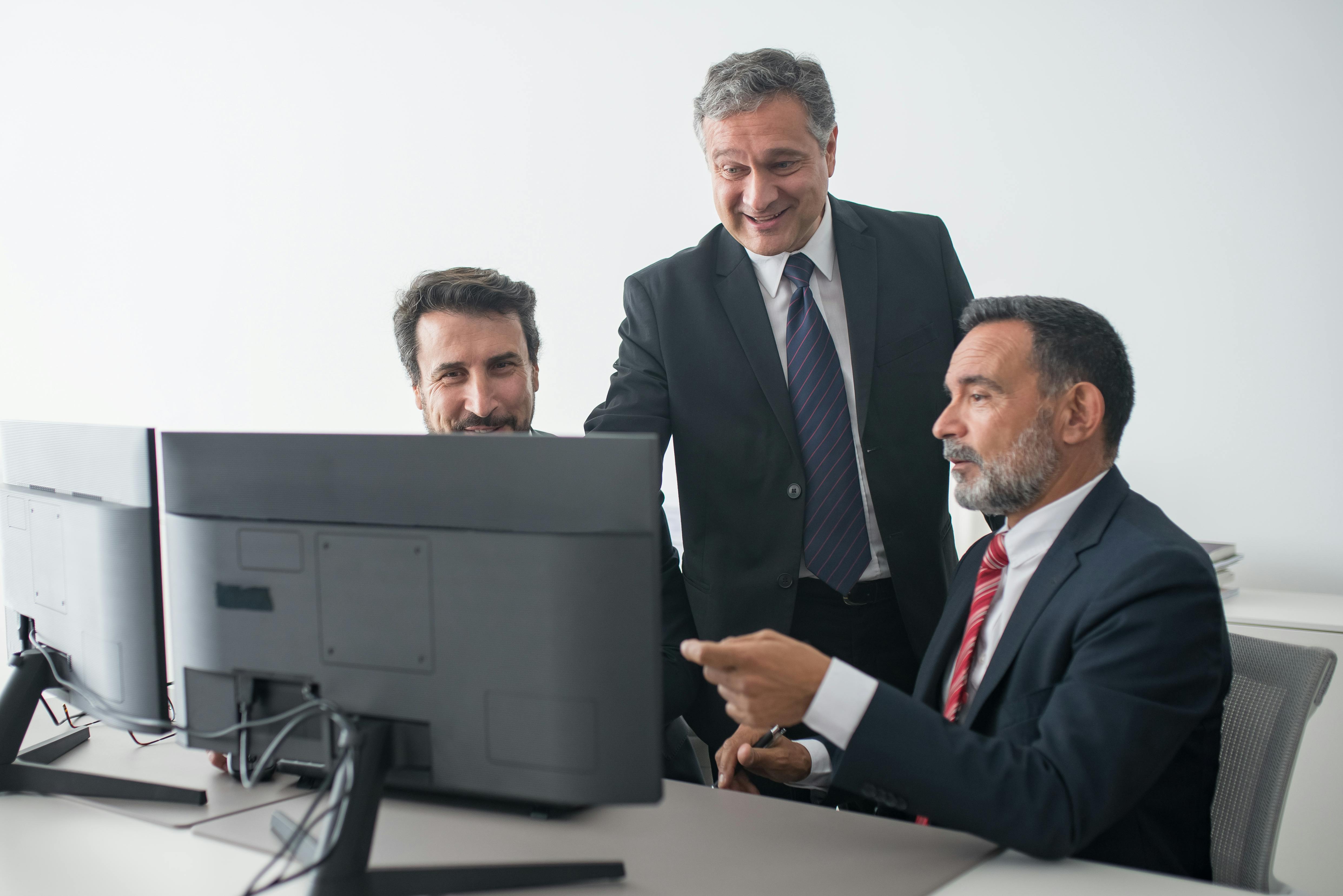 Men in Black Suit Jacket Looking at the Computer Screens · Free Stock Photo
