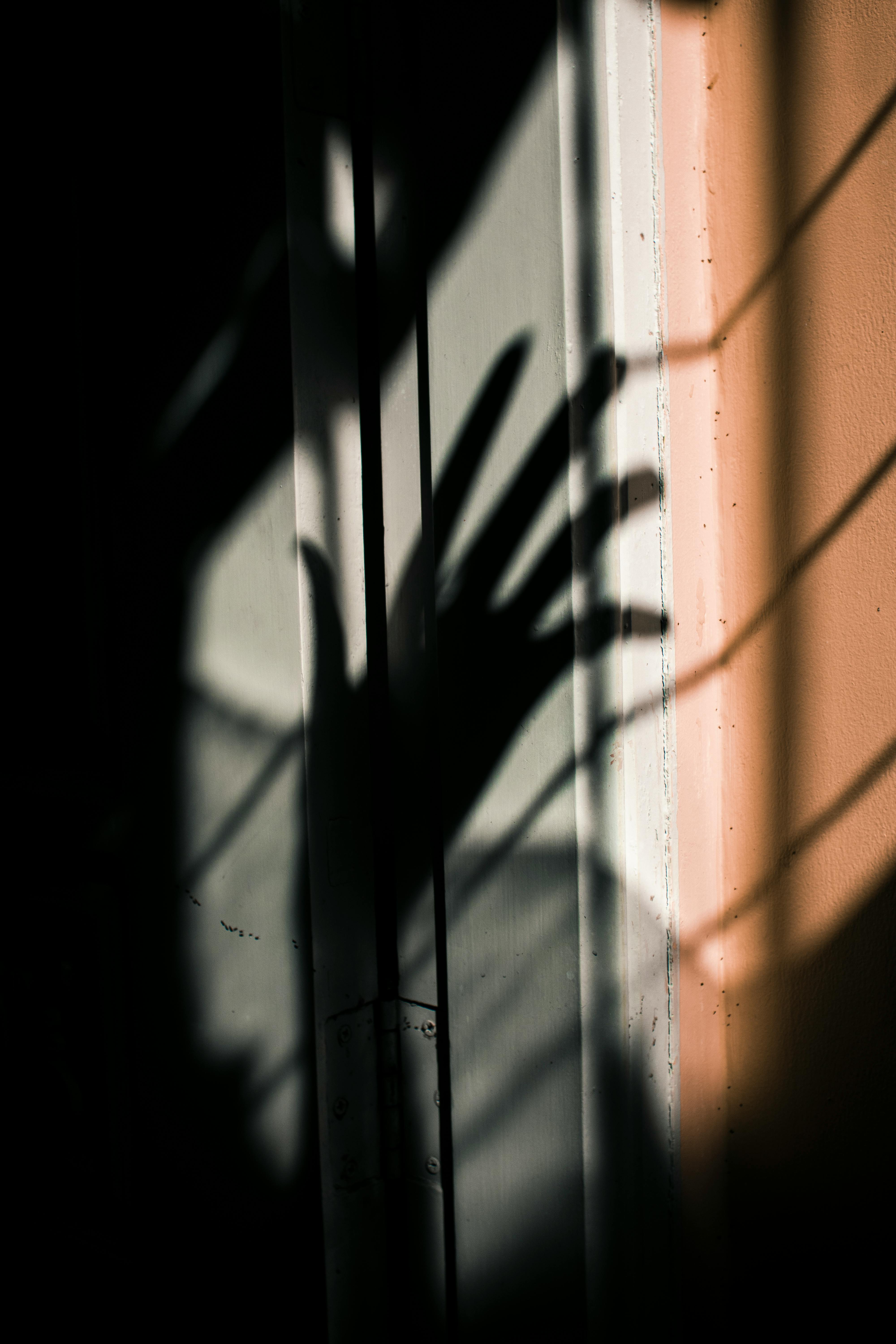Shadow of a Hand and a Window on a Wall · Free Stock Photo
