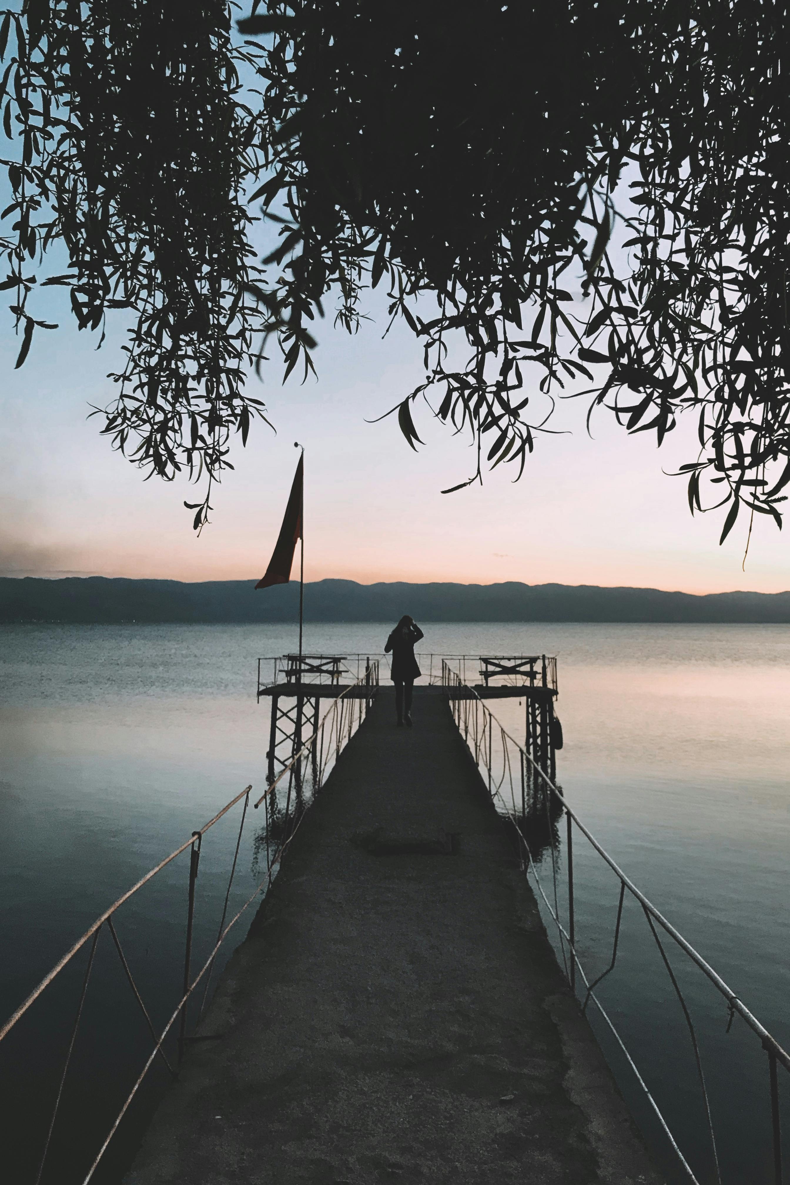 People Sitting on Brown Wooden Dock · Free Stock Photo