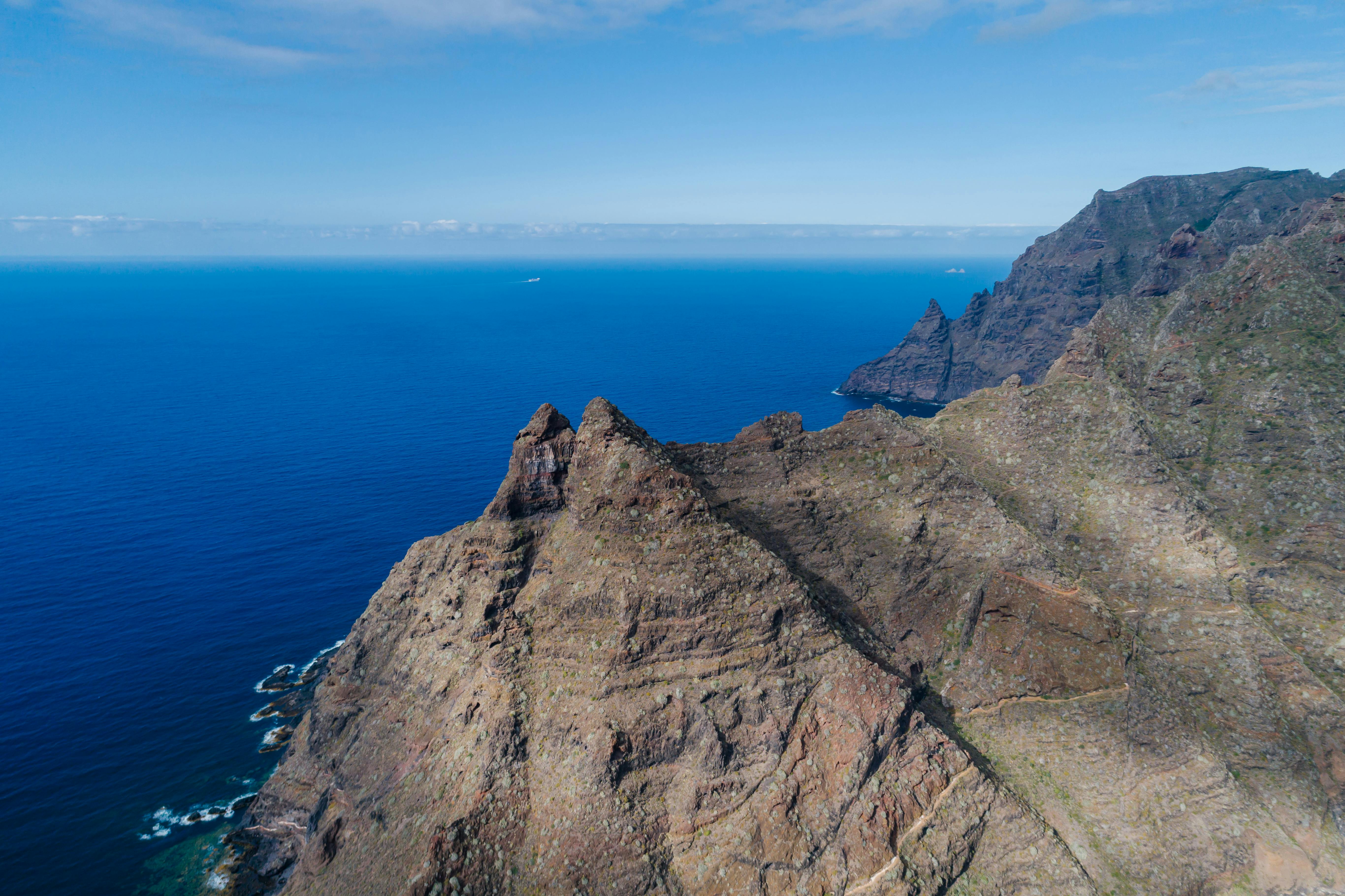 Back View of a Woman on the Edge of a Cliff · Free Stock Photo