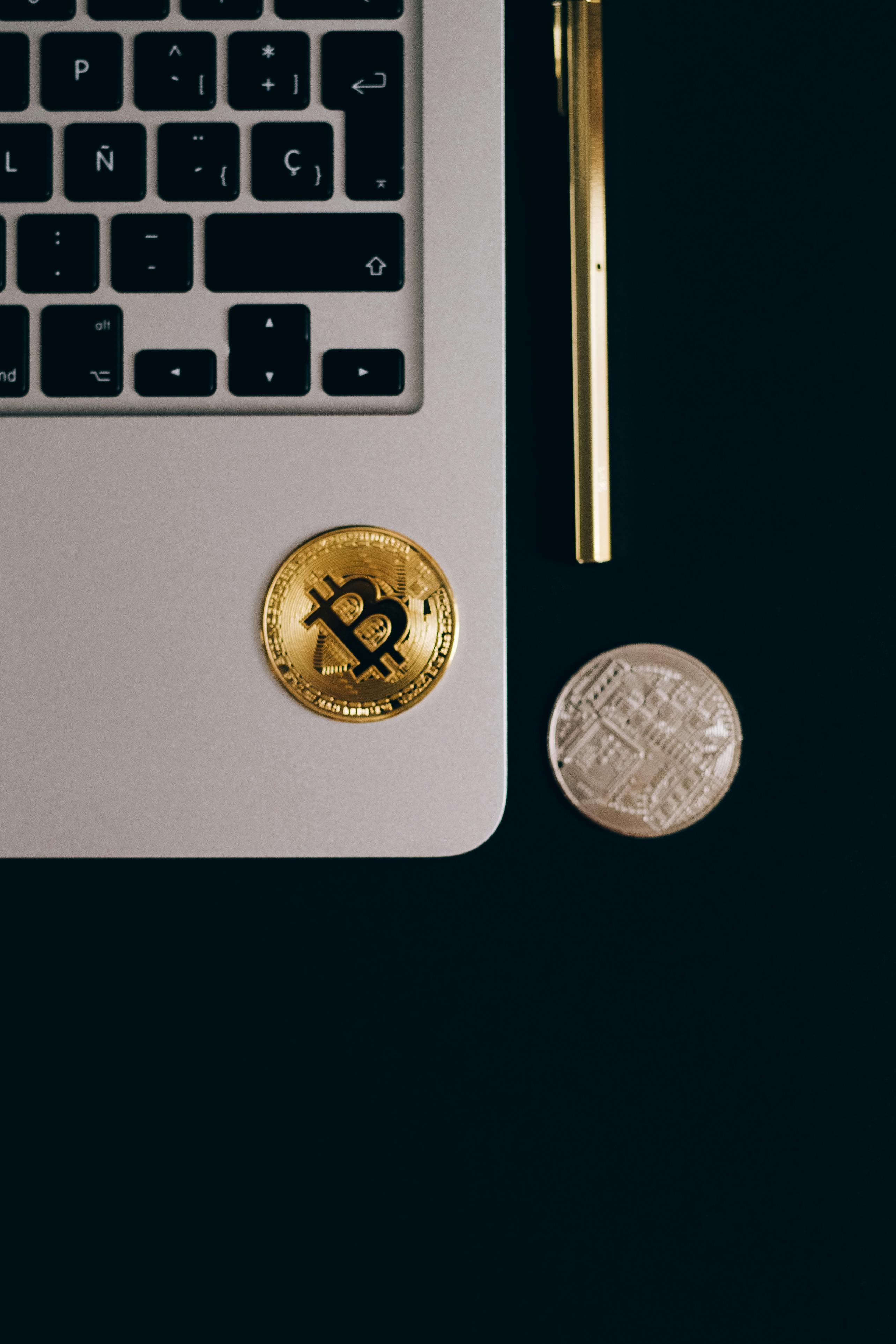 Silver and Gold Coins on the Laptop · Free Stock Photo