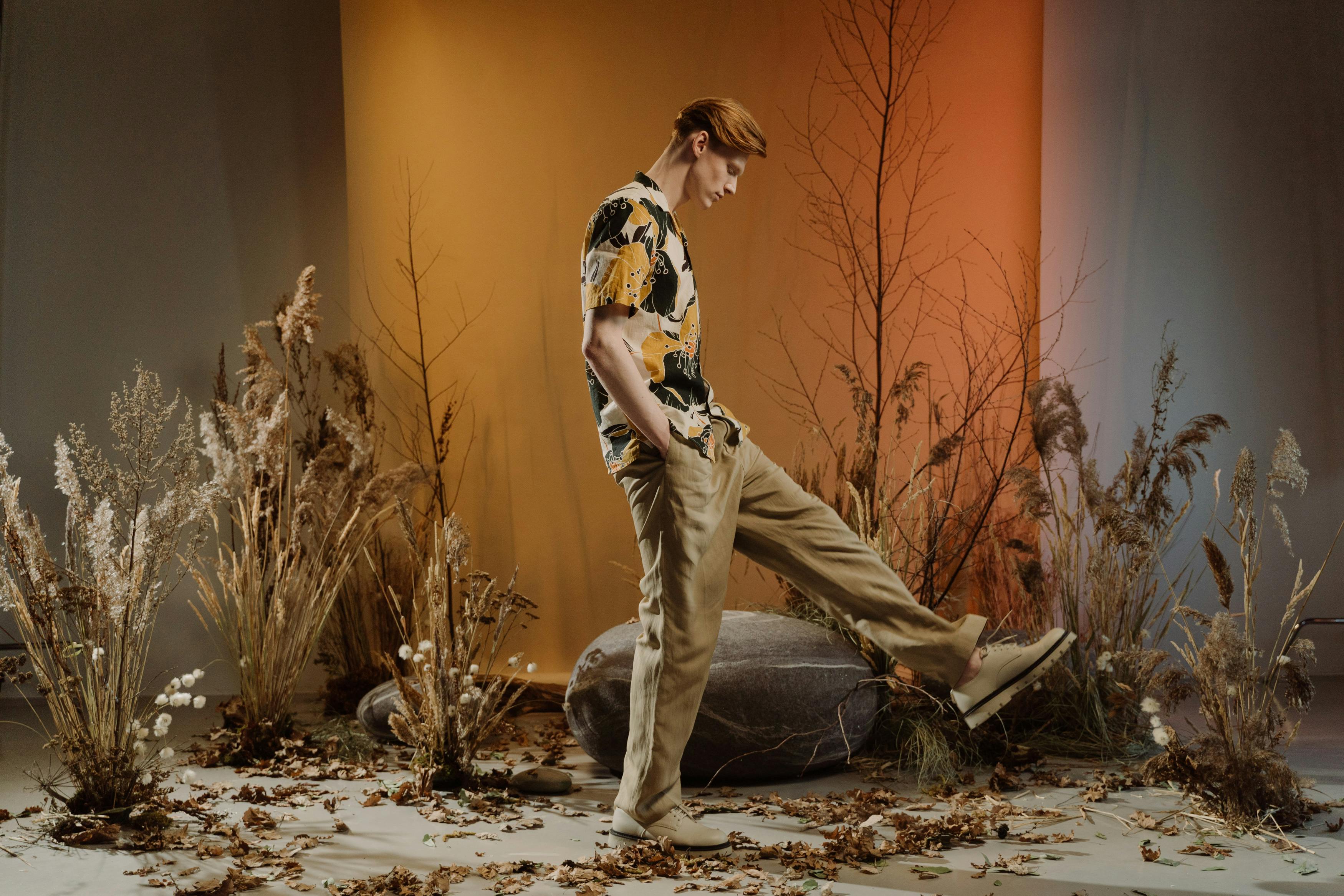 Man in Floral Shirt Kicking the Dried Flowers on the Floor · Free Stock ...