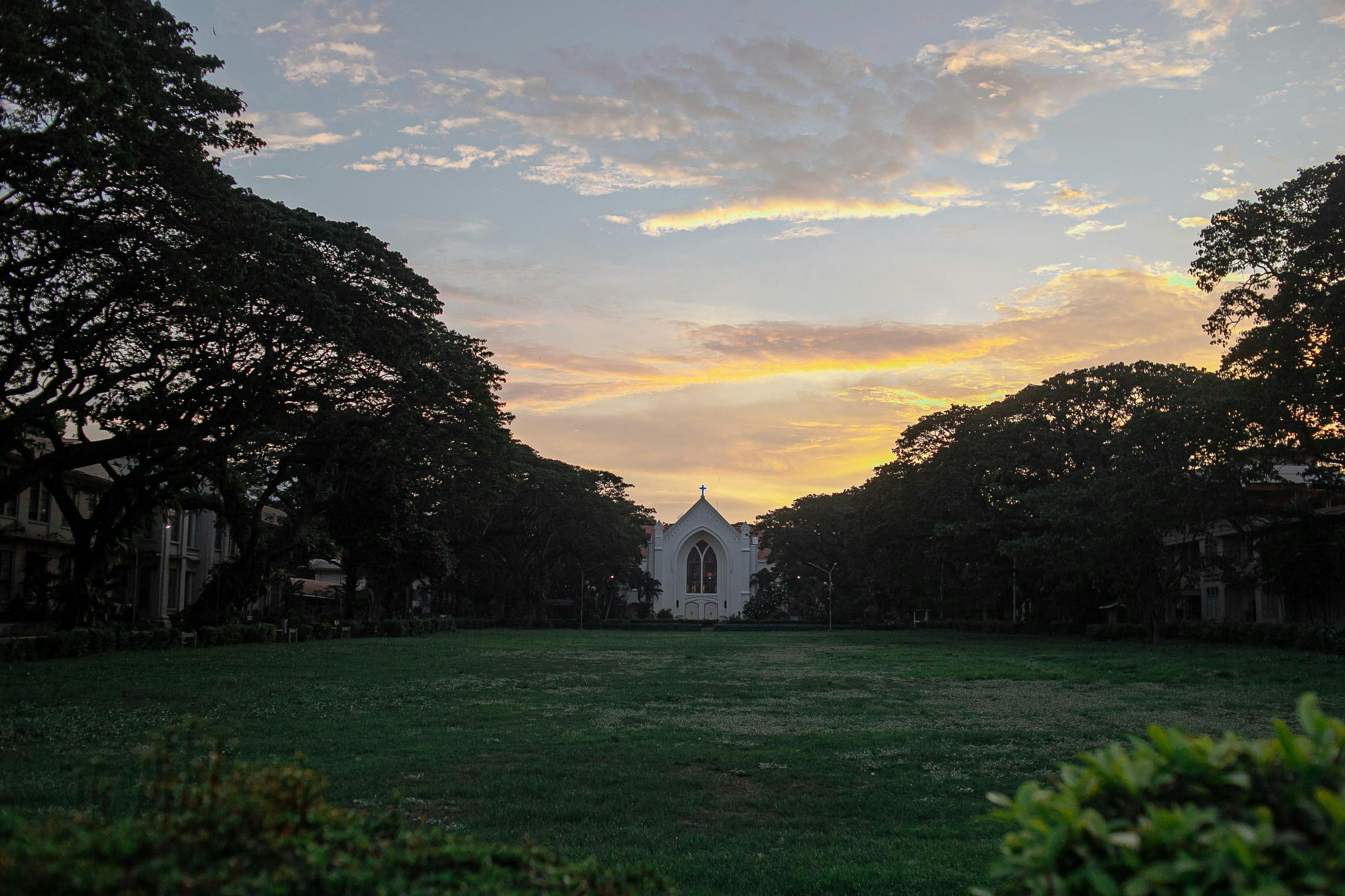 White Church Building on Green Grass Field during Sunset · Free Stock Photo