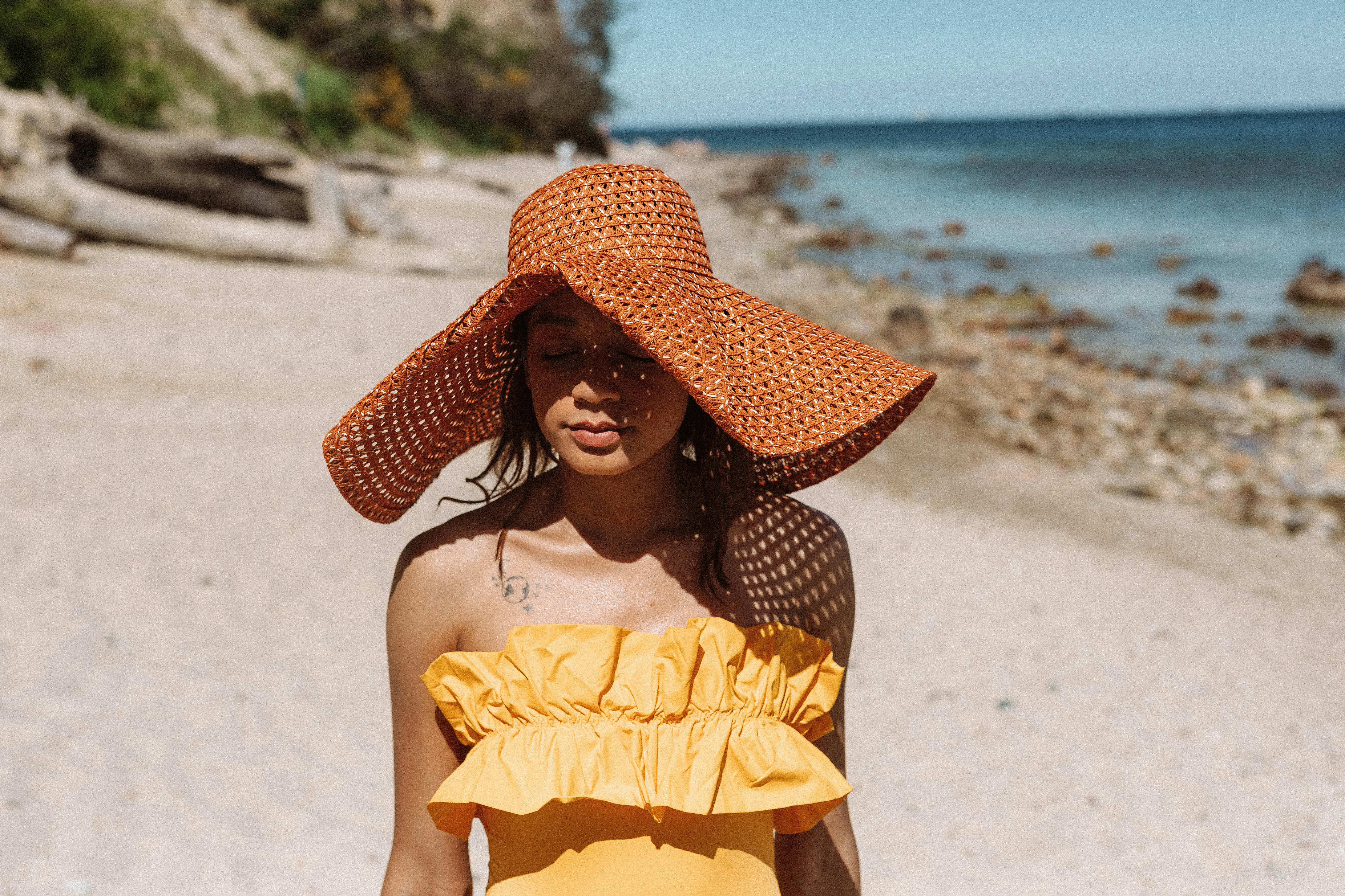 A Woman Wearing a Hat at the Beach · Free Stock Photo
