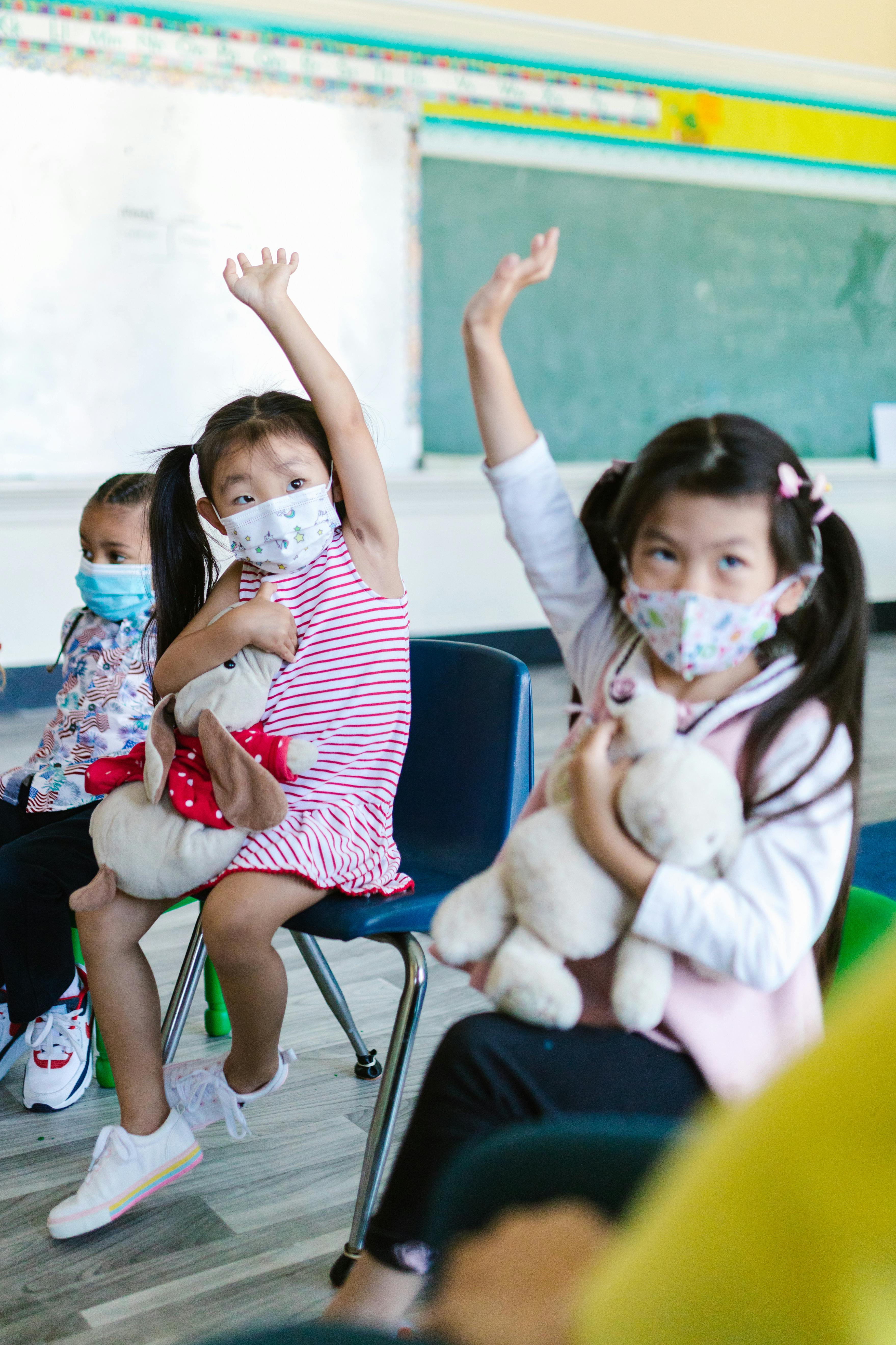 Children Wearing Face Masks Raising Hands · Free Stock Photo