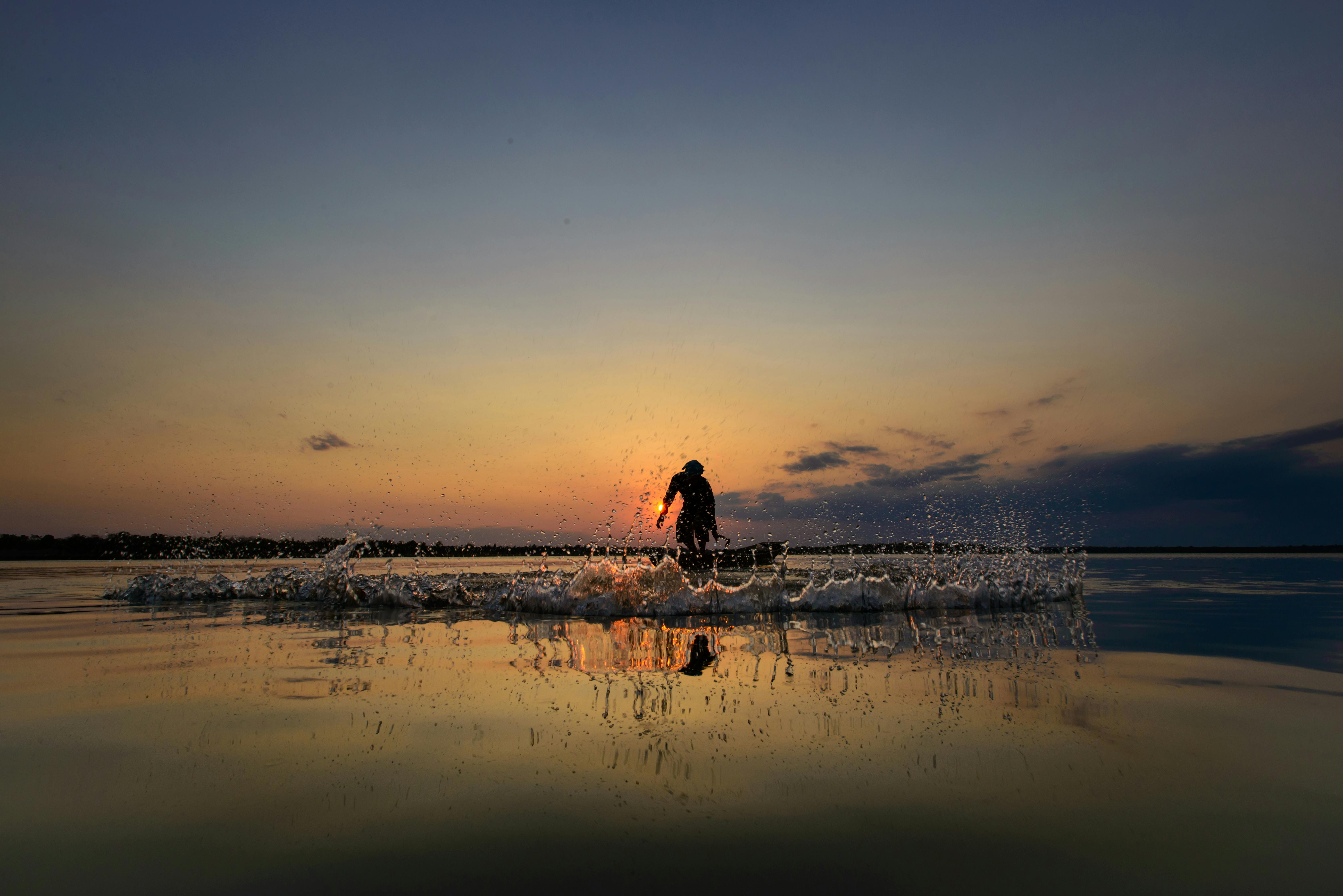 Person on Boat at Sunset · Free Stock Photo