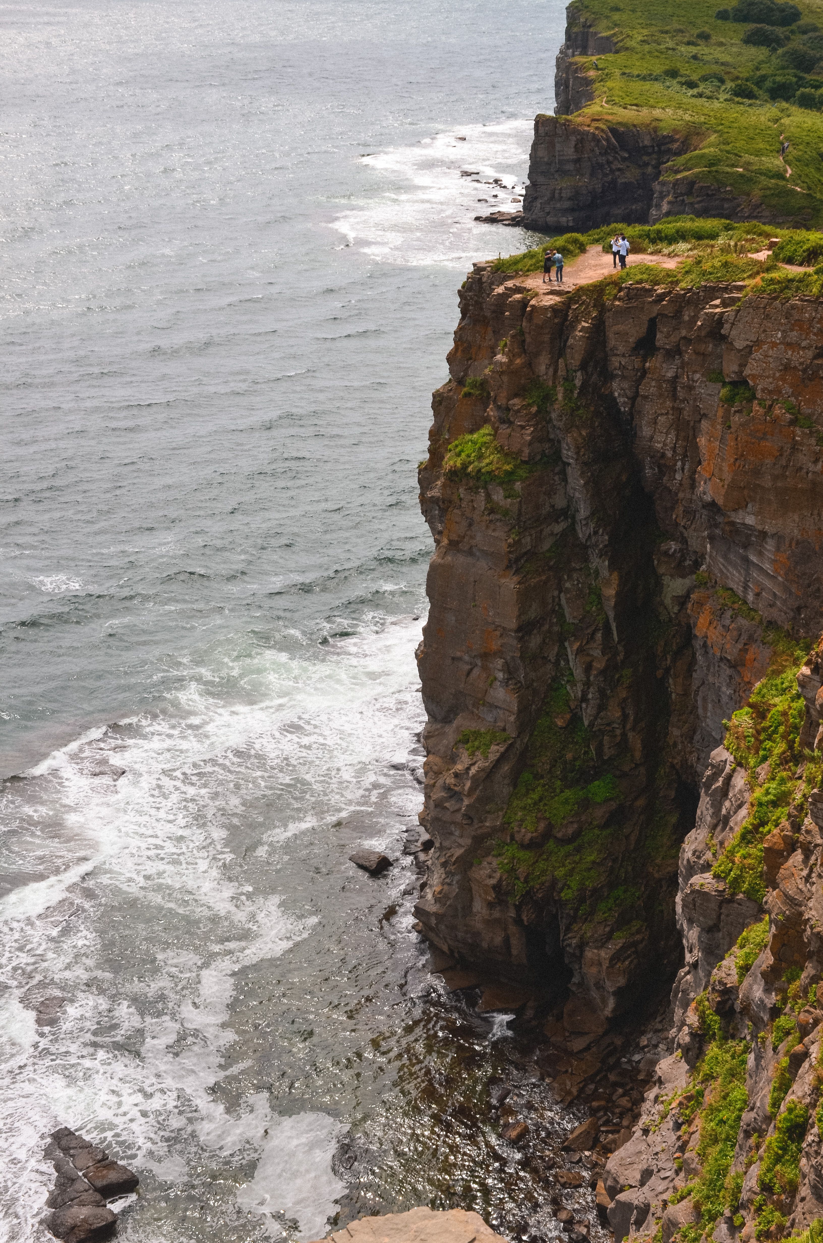 People Standing at the Edge of a Costal Cliff · Free Stock Photo