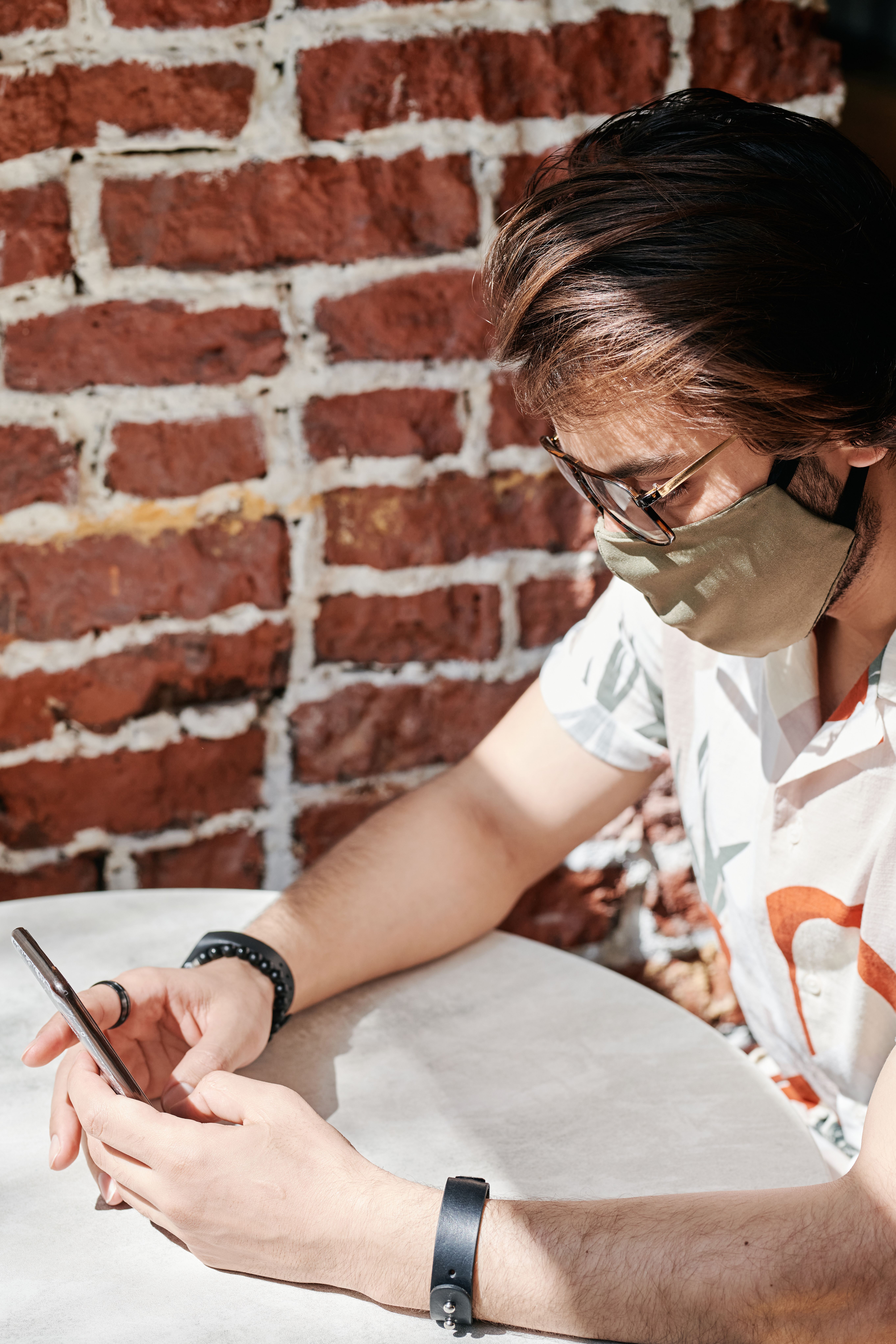 A Man with a Facemask Using His Cellphone · Free Stock Photo