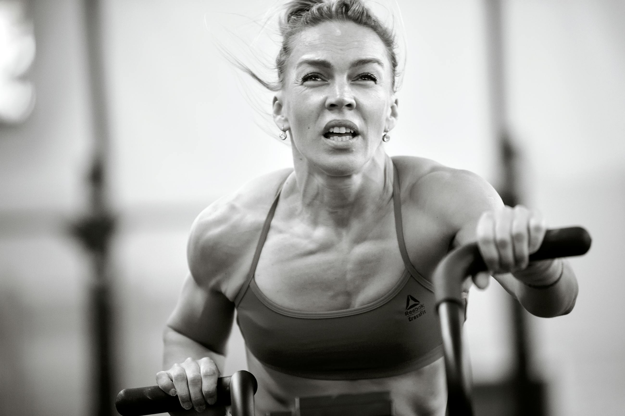 A Grayscale Photo of a Woman Exercising · Free Stock Photo