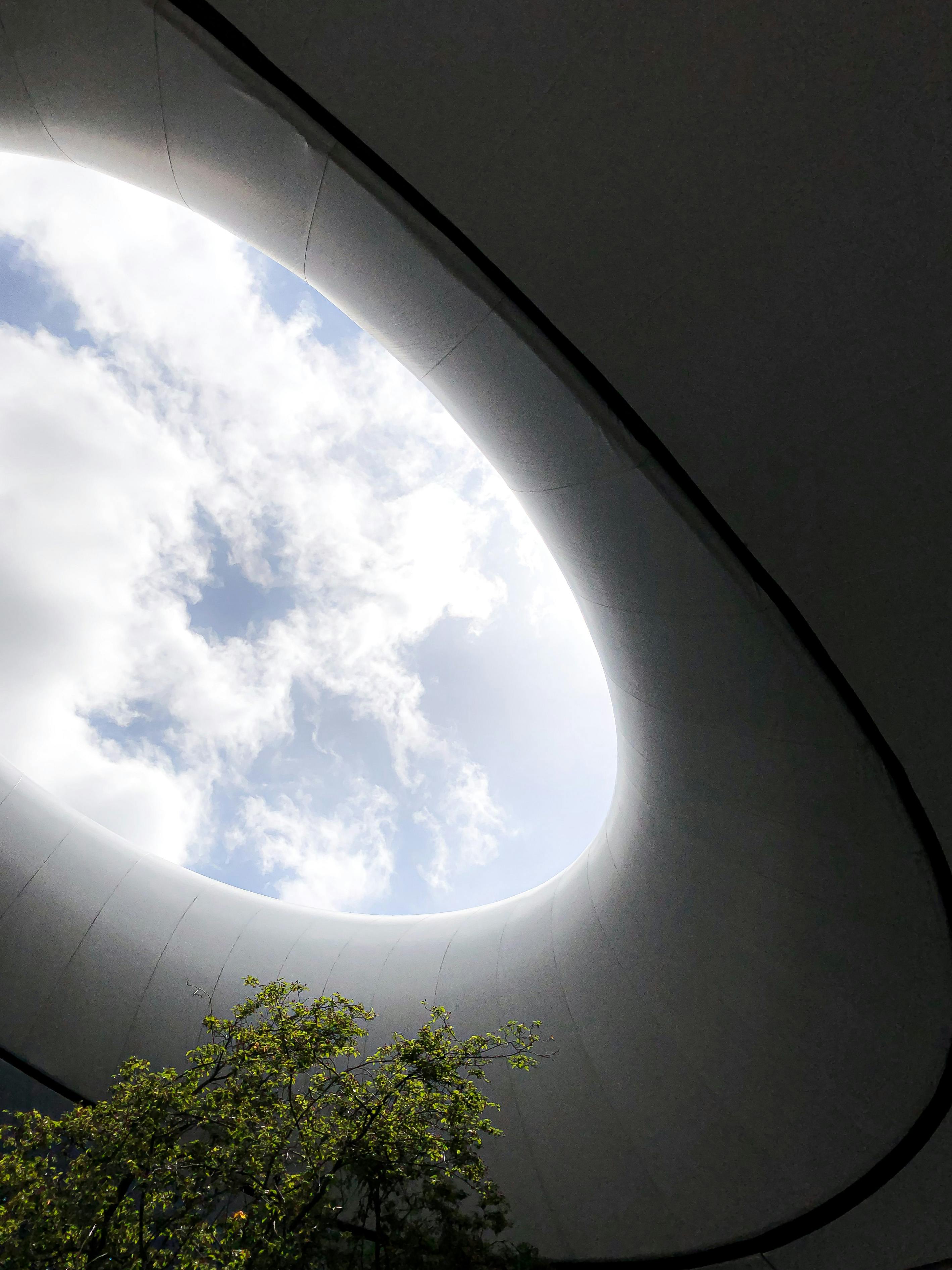 Fluffy Clouds Seen through Round Window · Free Stock Photo