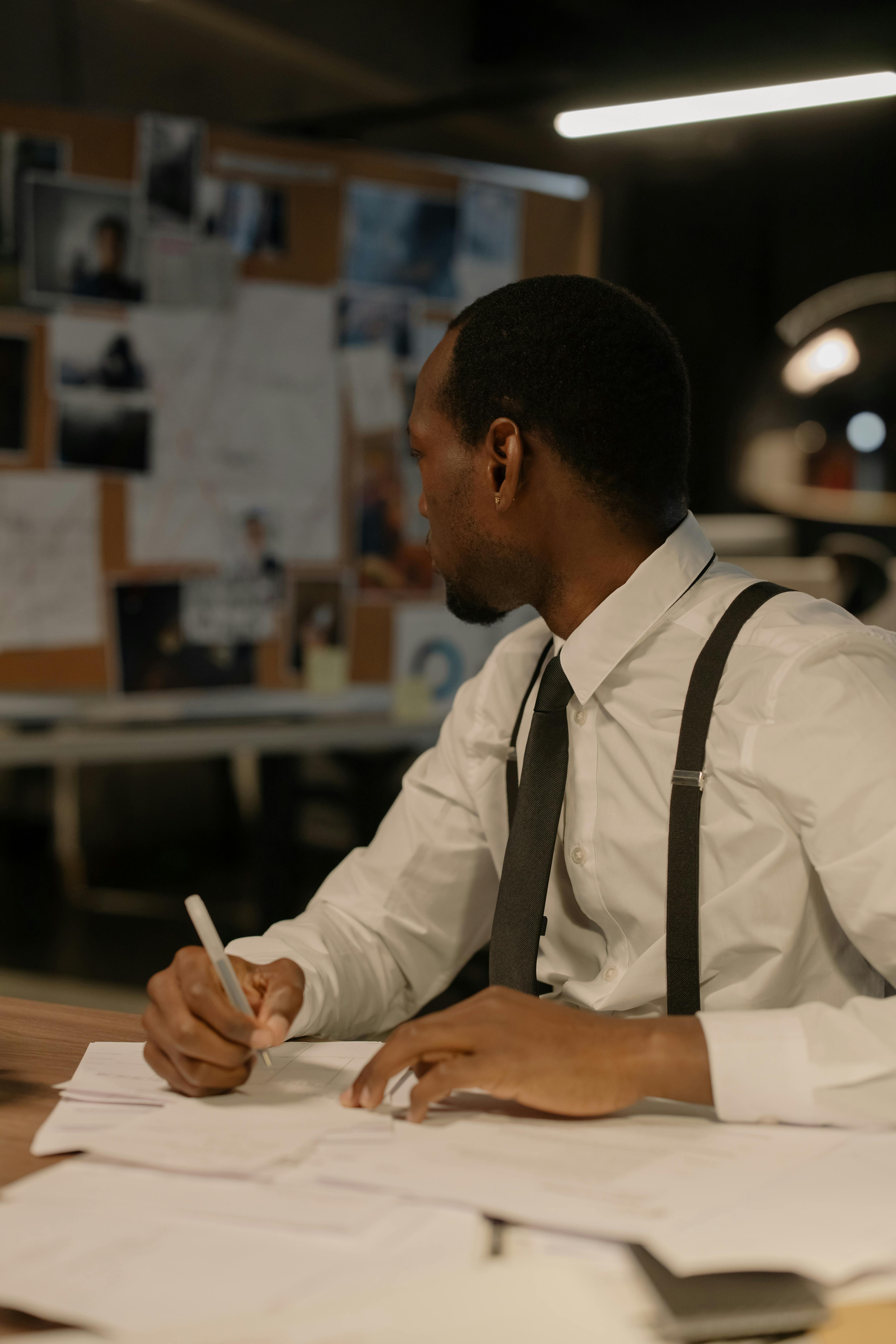 Man in Gray Shirt Looking at Pictures · Free Stock Photo