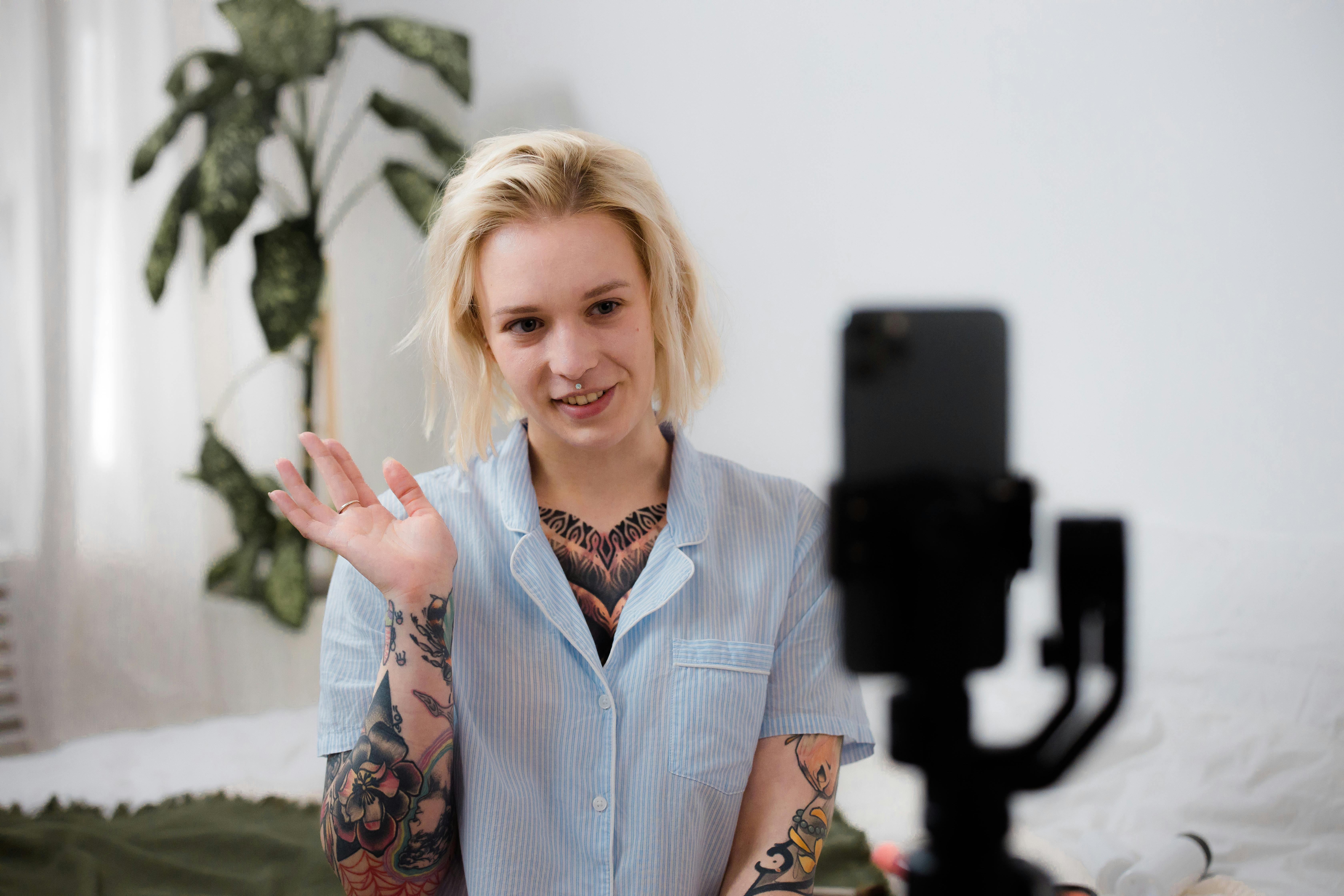 Tattooed Woman Filming Herself With Mobile Phone · Free Stock Photo