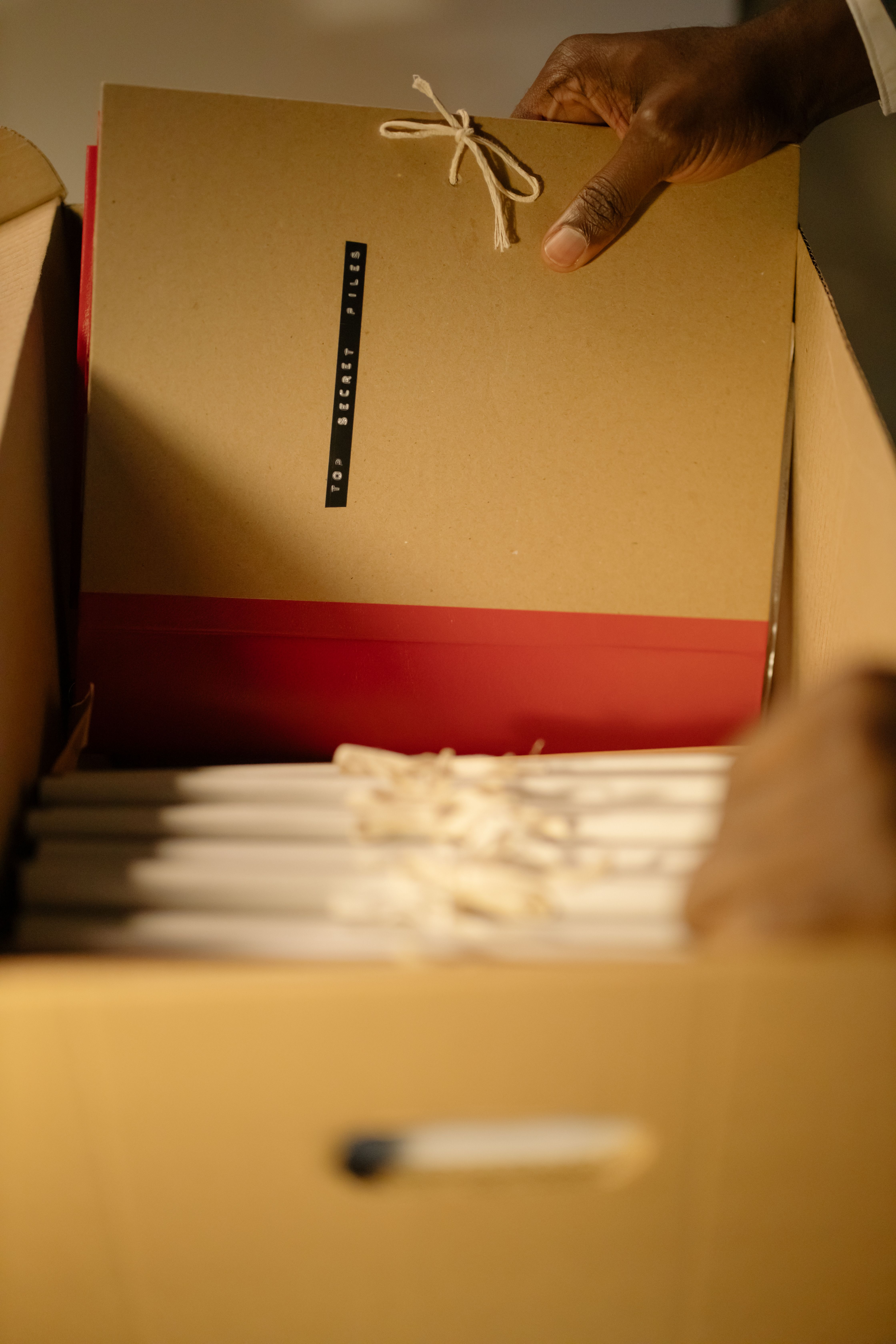 A Person Holding a Folder of a Top Secret Files Label · Free Stock Photo