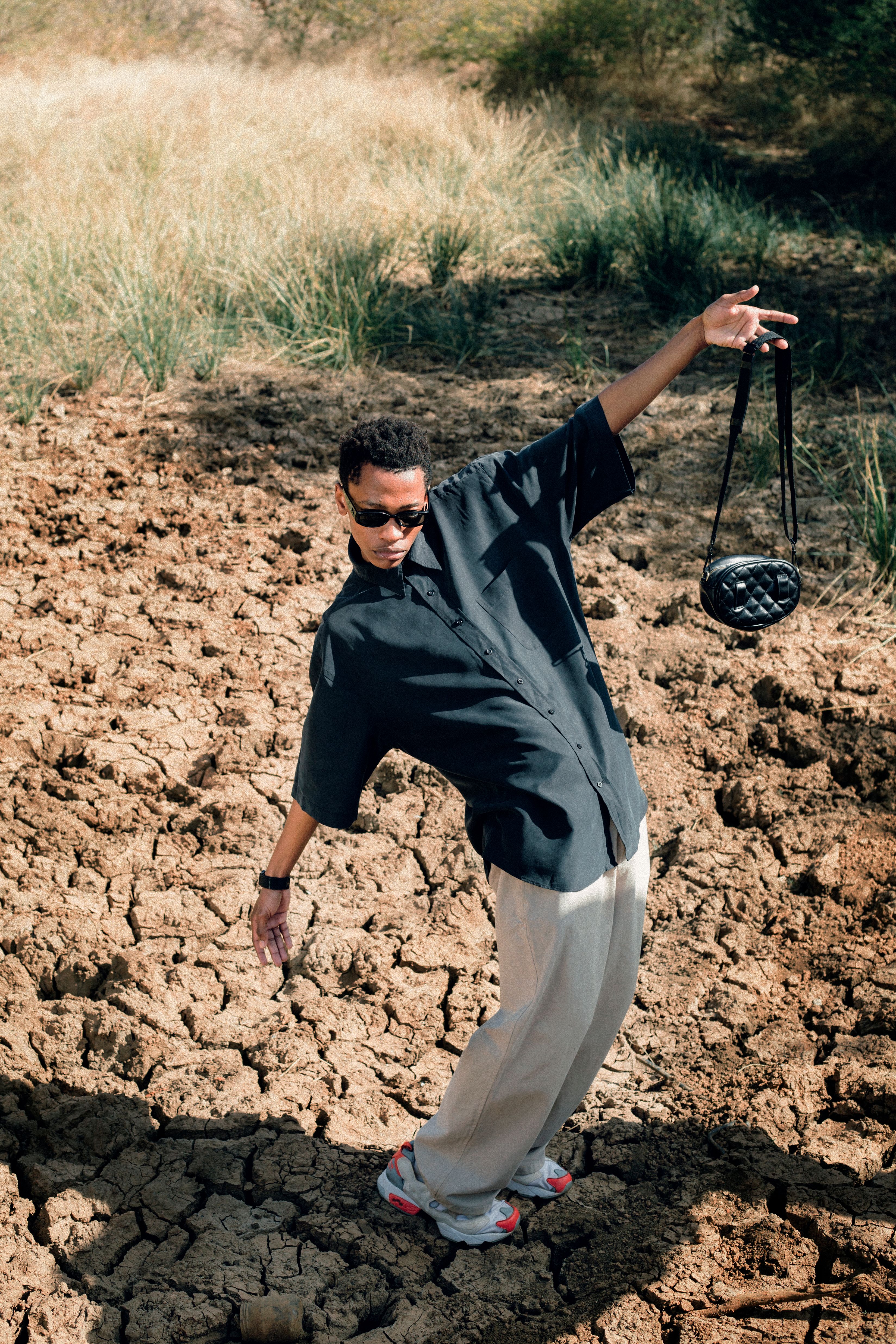 Man Posing with a Handbag · Free Stock Photo