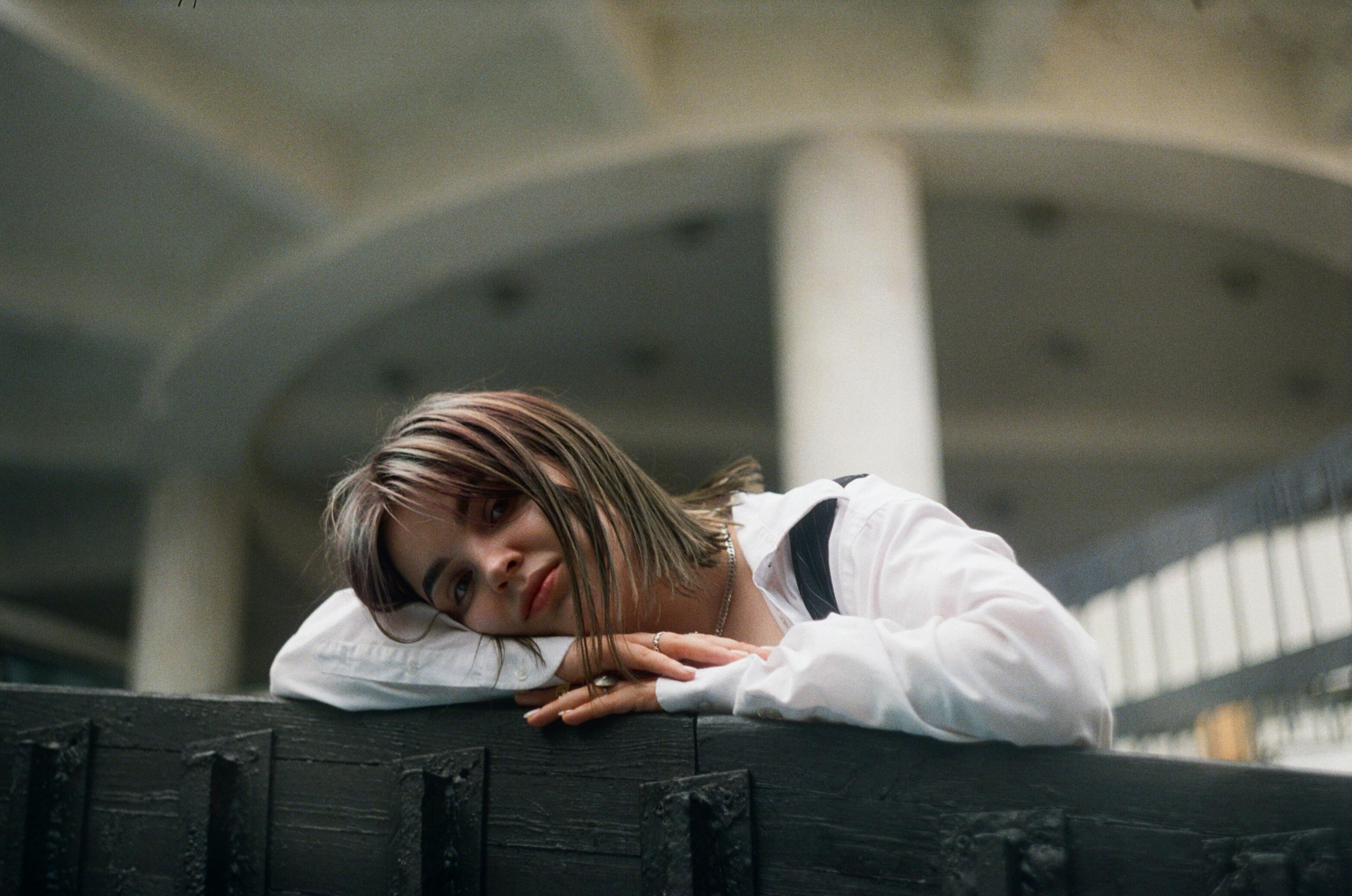 Woman Lying on Railing · Free Stock Photo