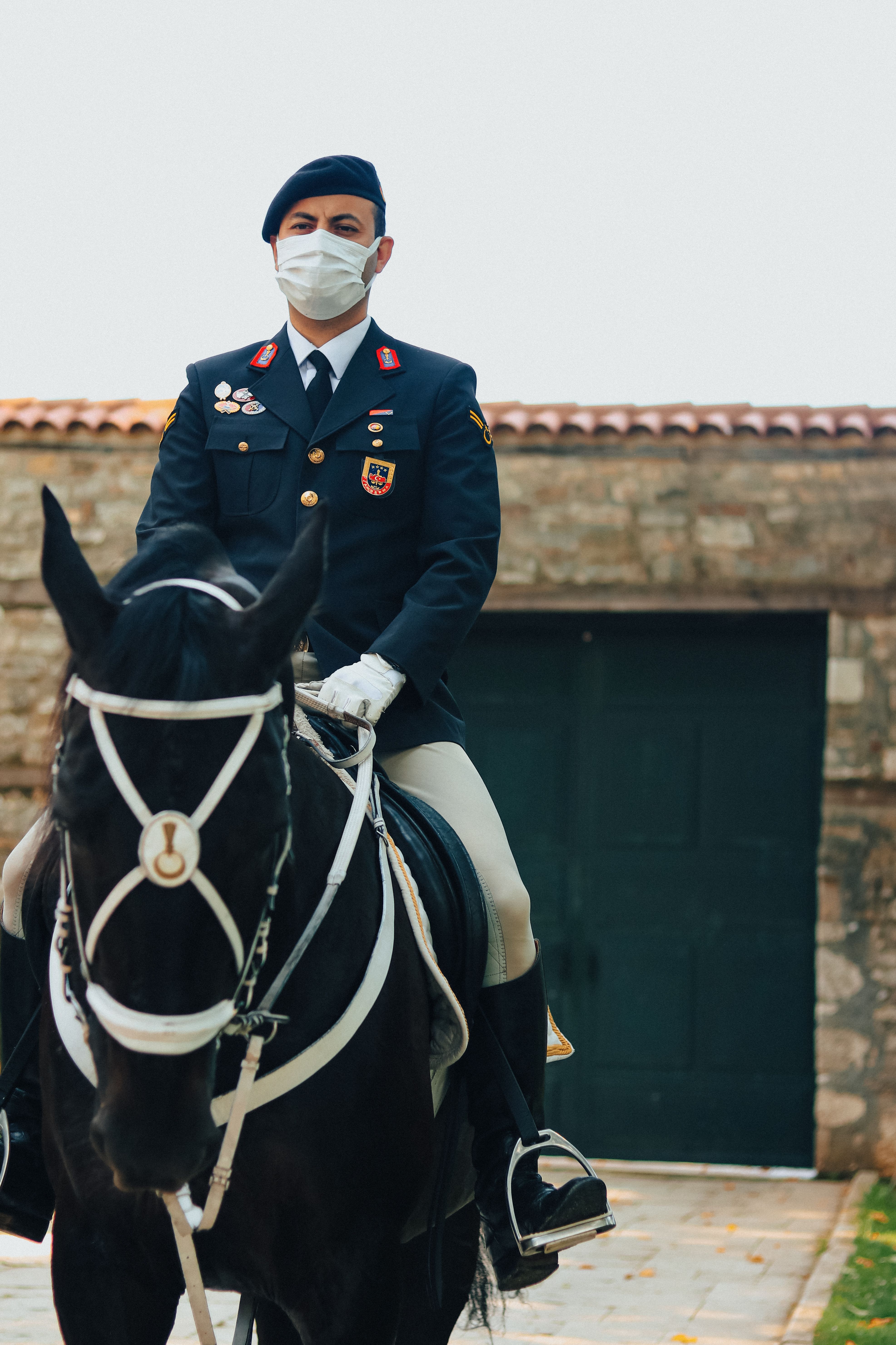 Soldier Riding on a Horse with Face Mask on · Free Stock Photo