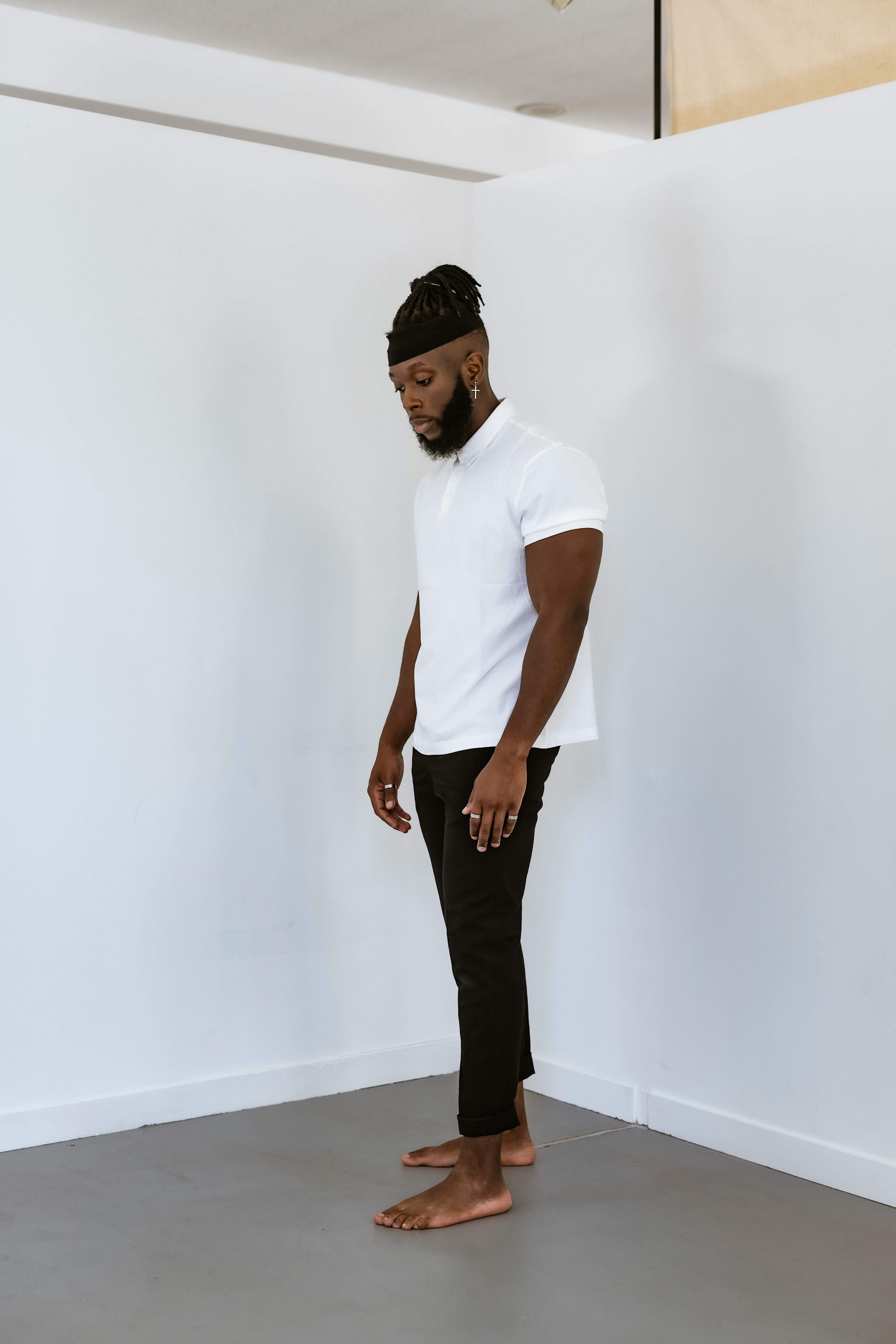 Man Standing Tilted and Looking at Modern Art Pictures · Free Stock Photo