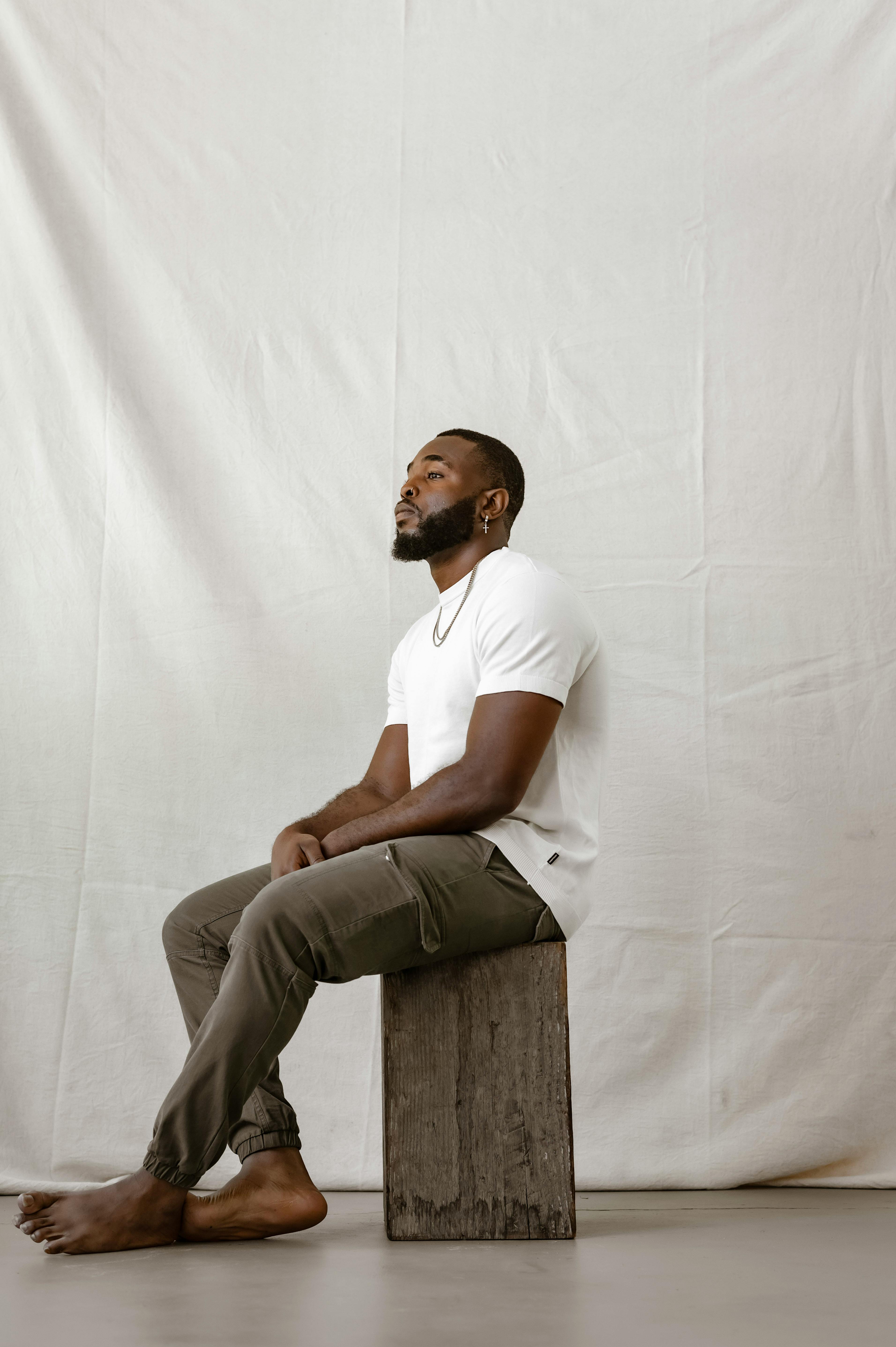 A Man Leaning Forward with His Hands Together · Free Stock Photo