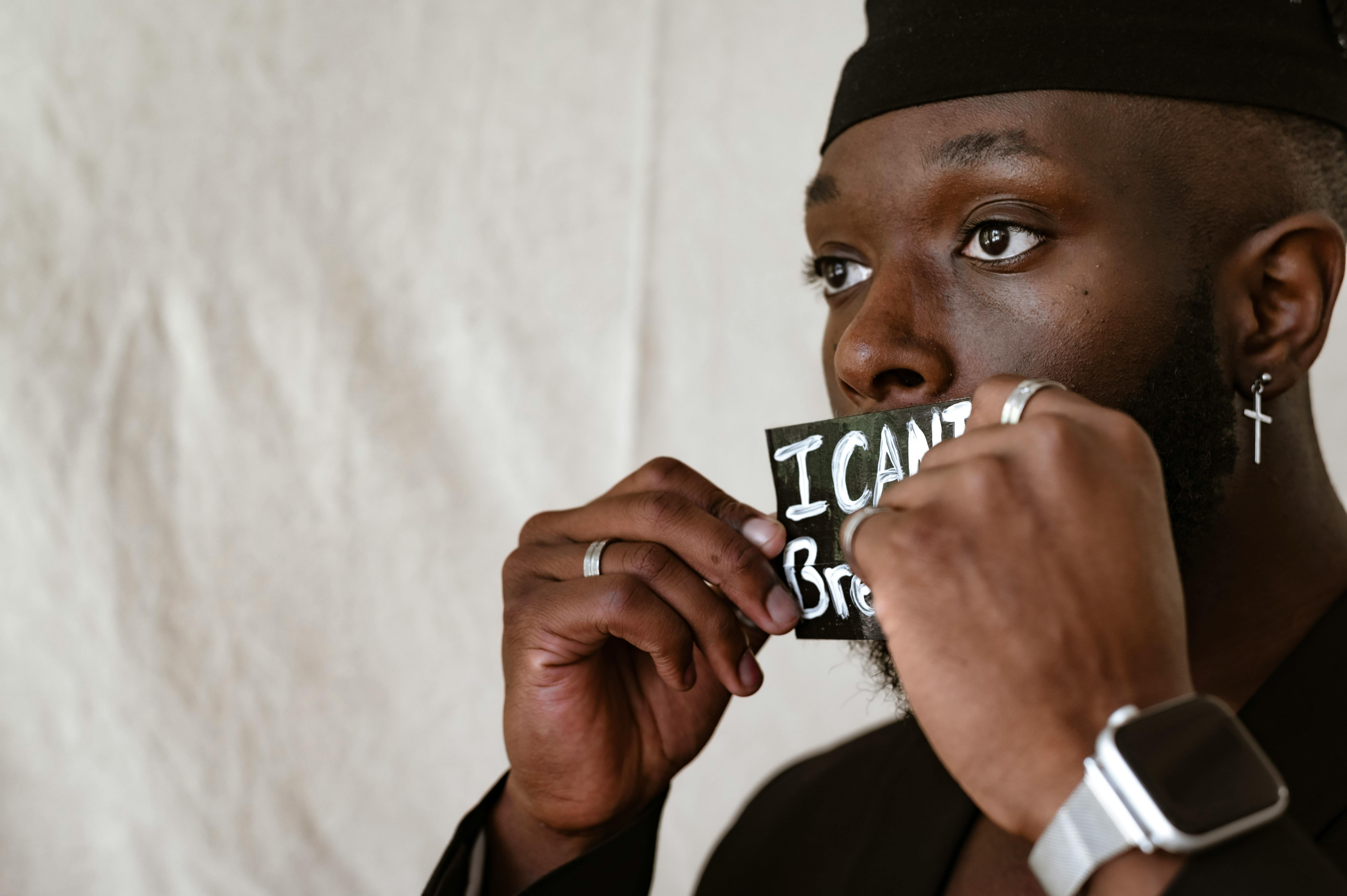 Man Holding Anti Racism Card on Mouth · Free Stock Photo