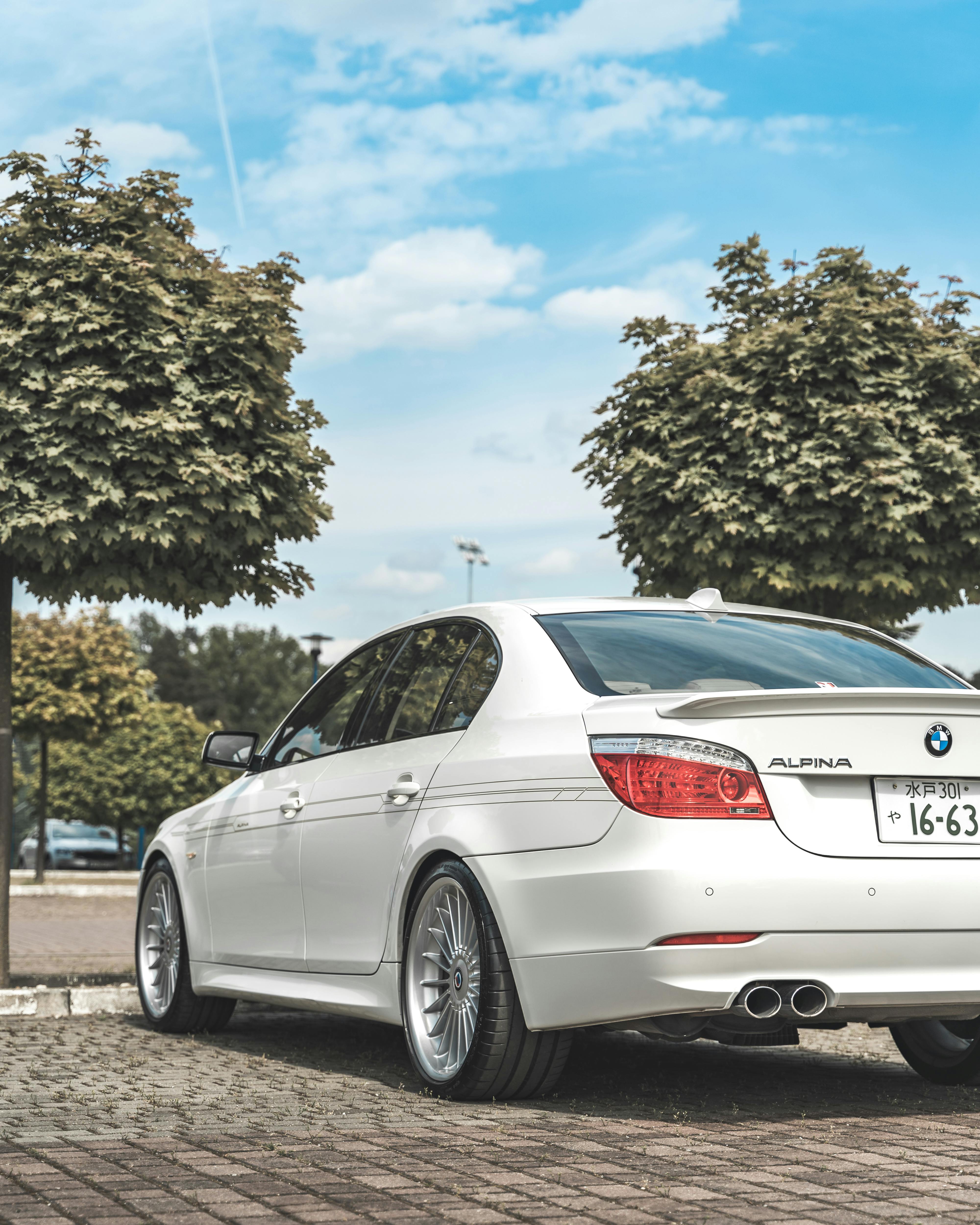 White BMW Car Parked Near a Tree · Free Stock Photo