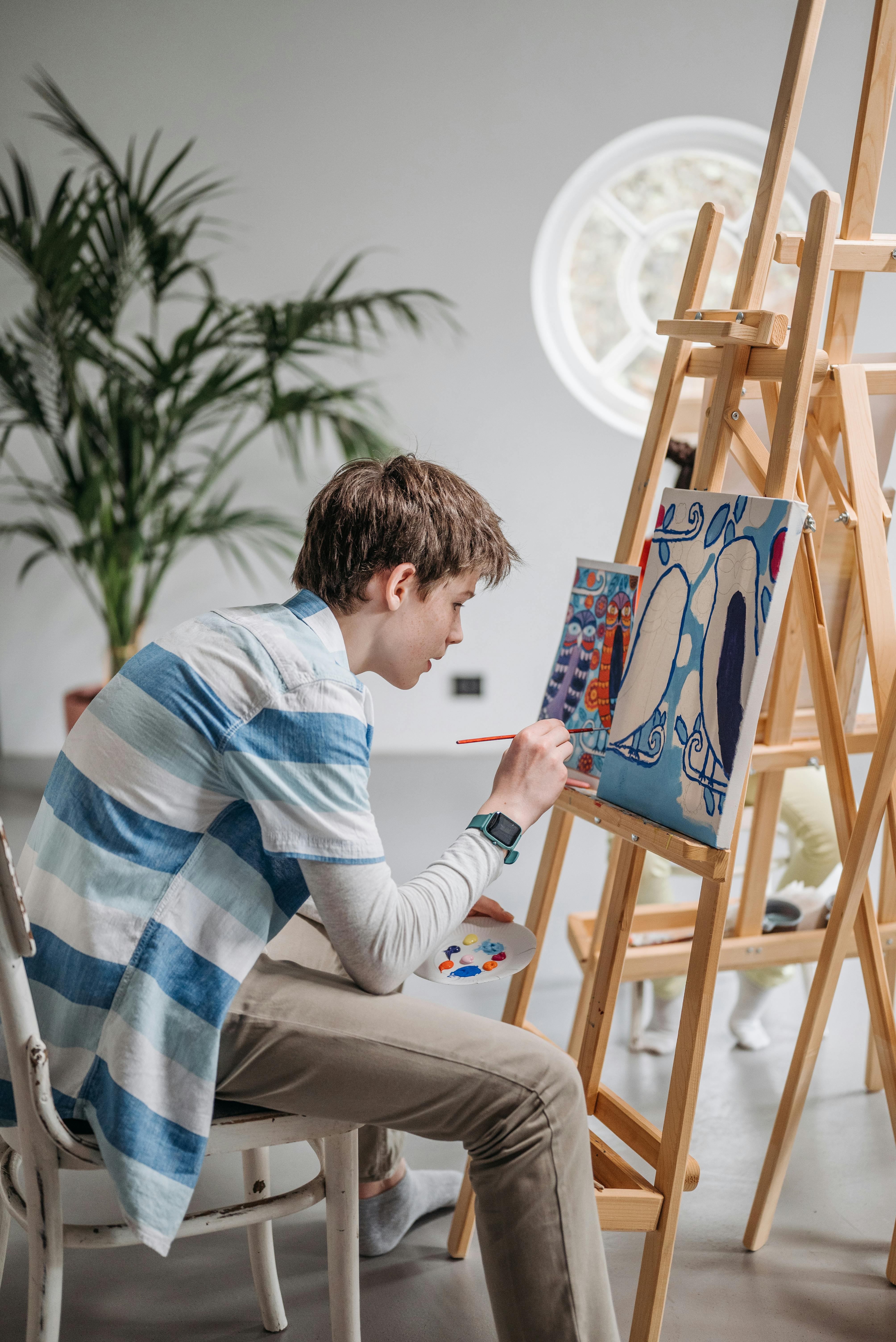 Photo of a Boy Painting on Canvas · Free Stock Photo