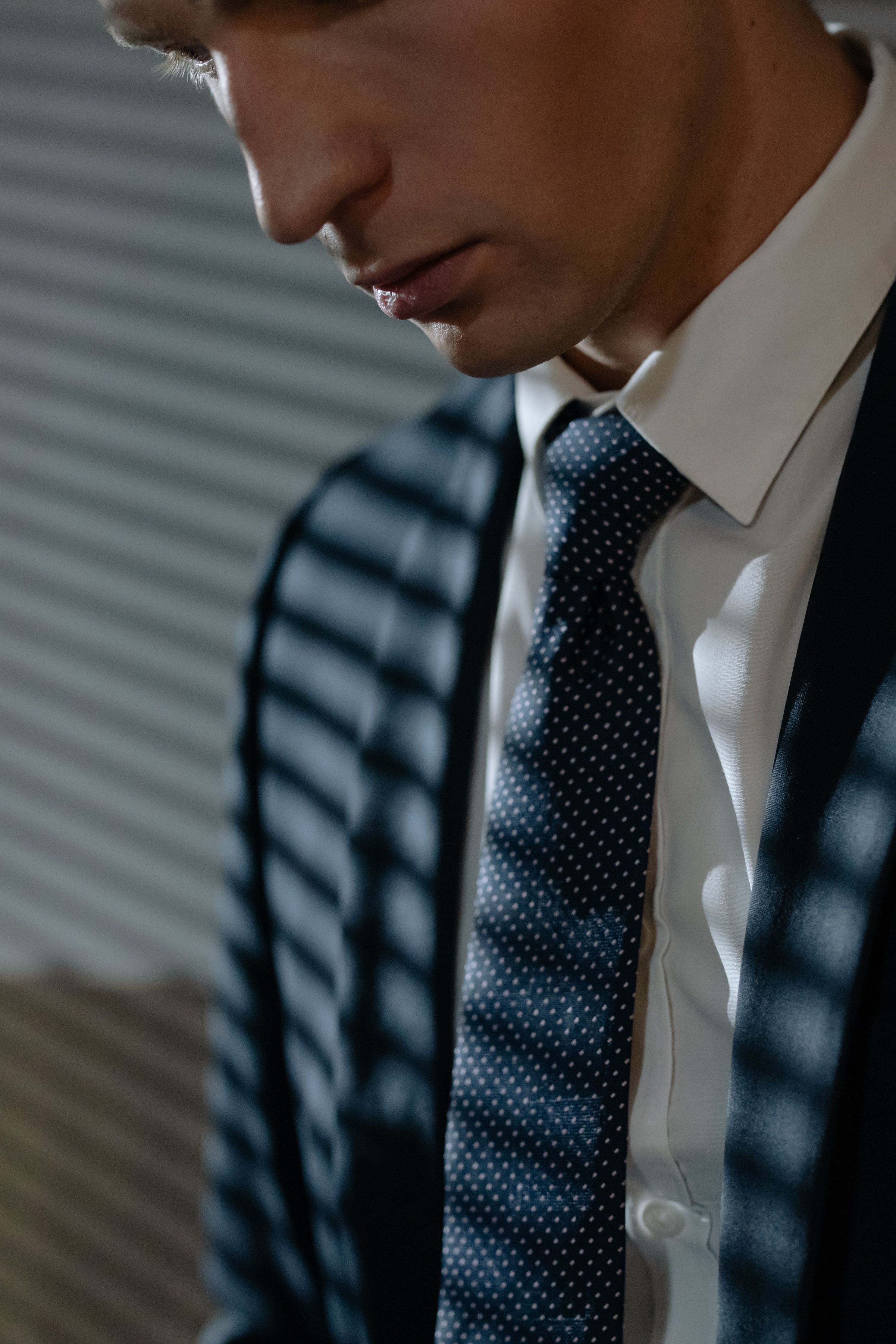 Blinds Casting Shadows on the Man in Blue Suit · Free Stock Photo