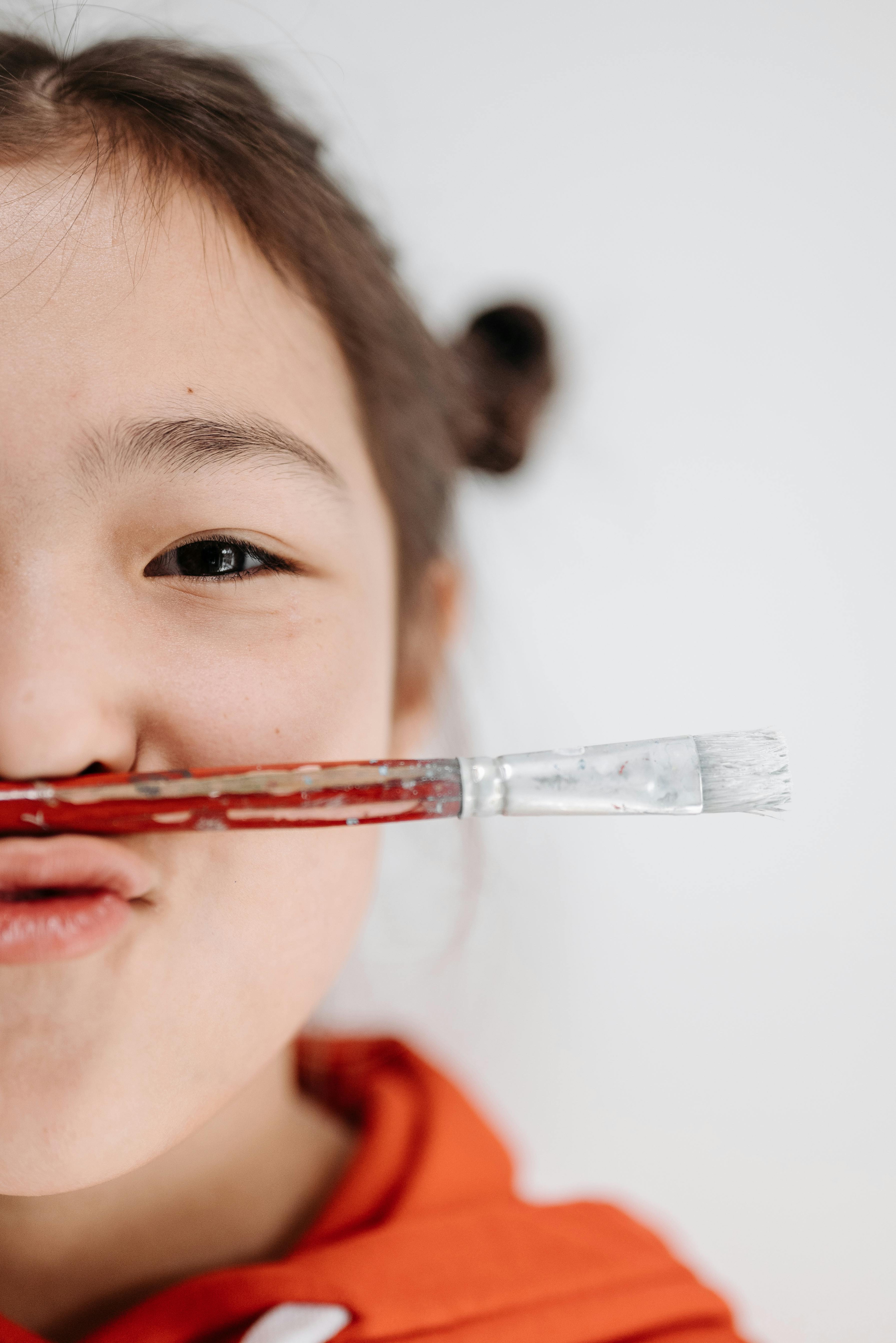 Person Applying Face Paint on a Girl · Free Stock Photo