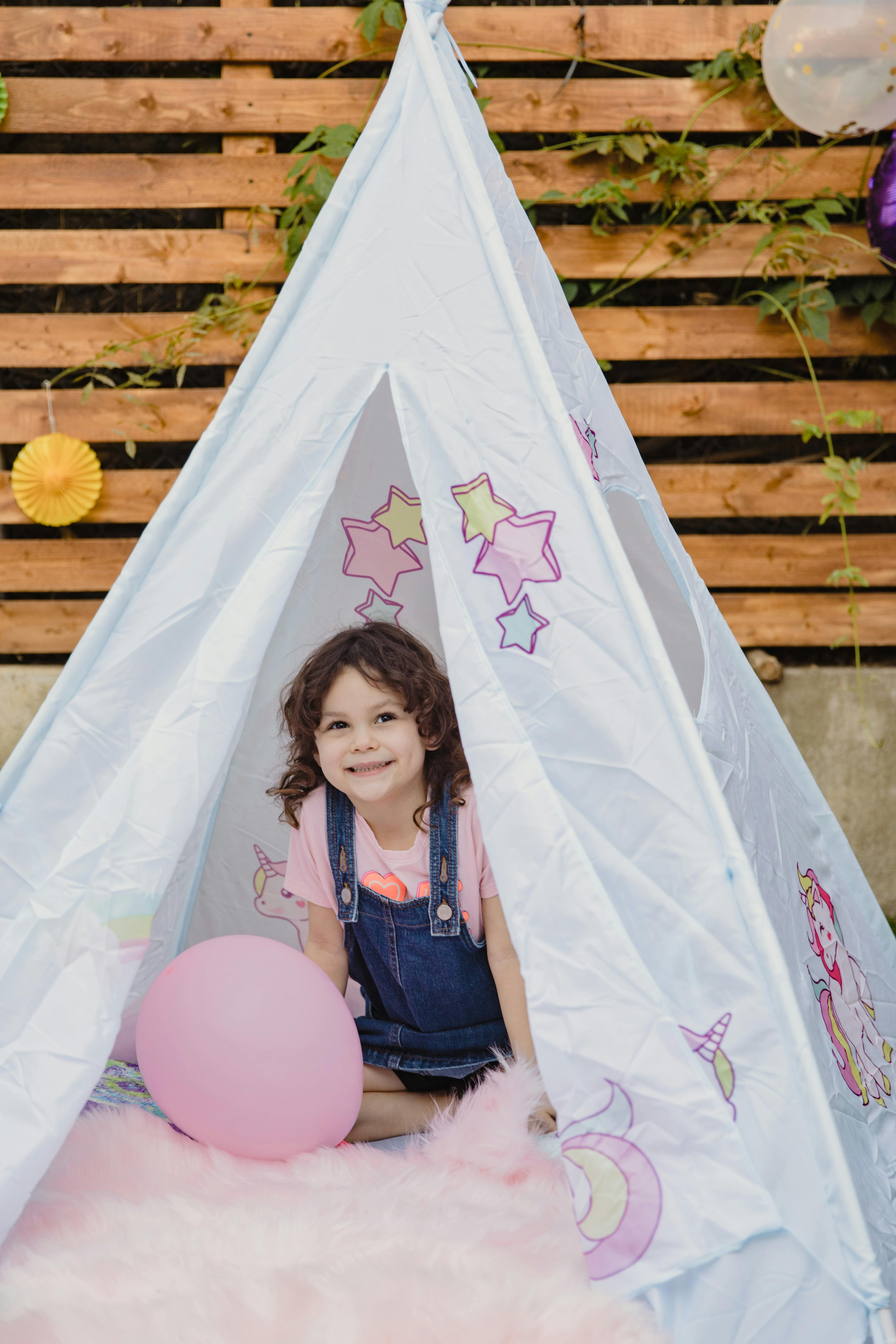 Pretty Young Girl Sitting Inside a Teepee · Free Stock Photo
